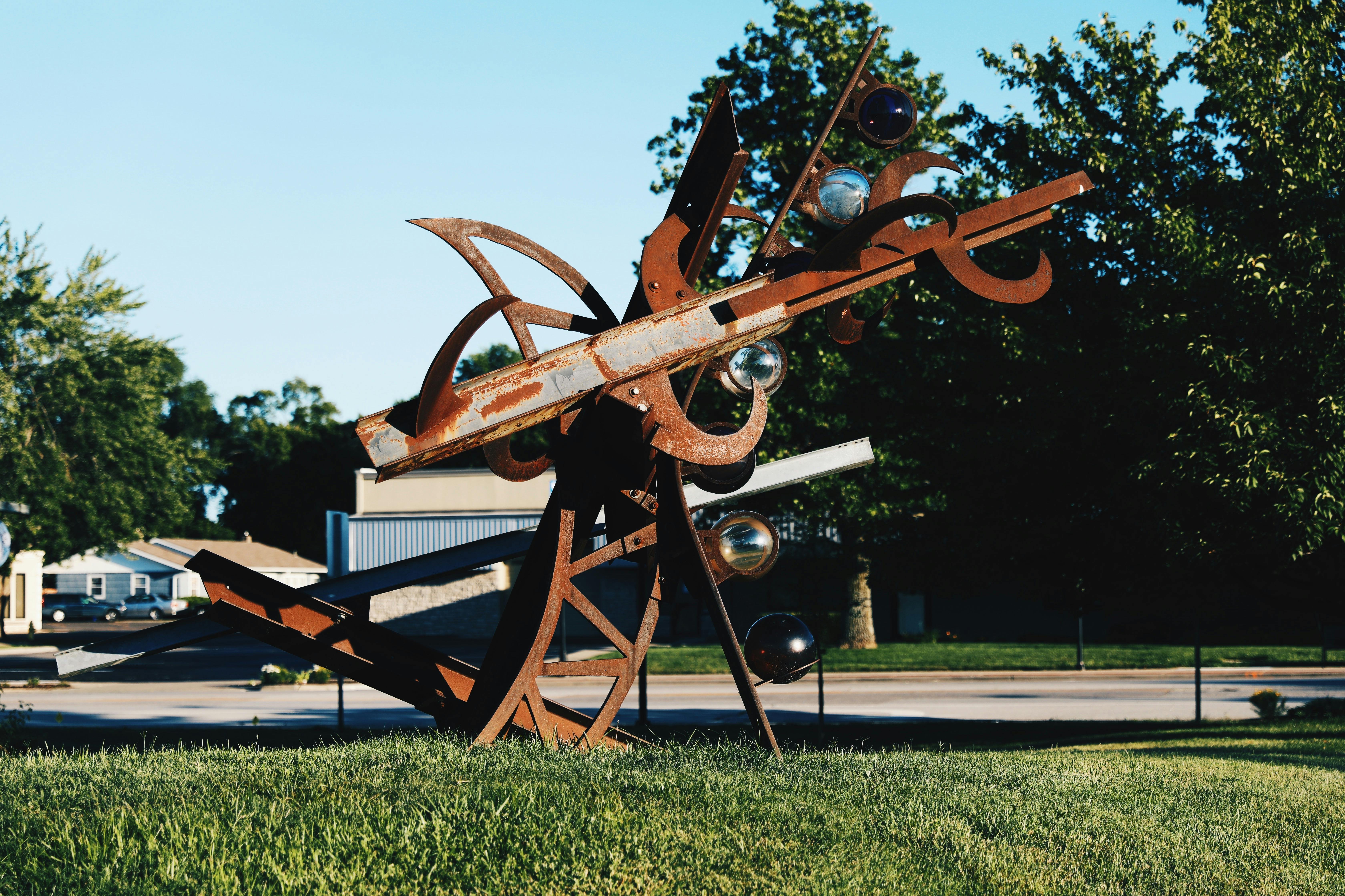 Rusty Sculpture on Lawn in Town · Free Stock Photo