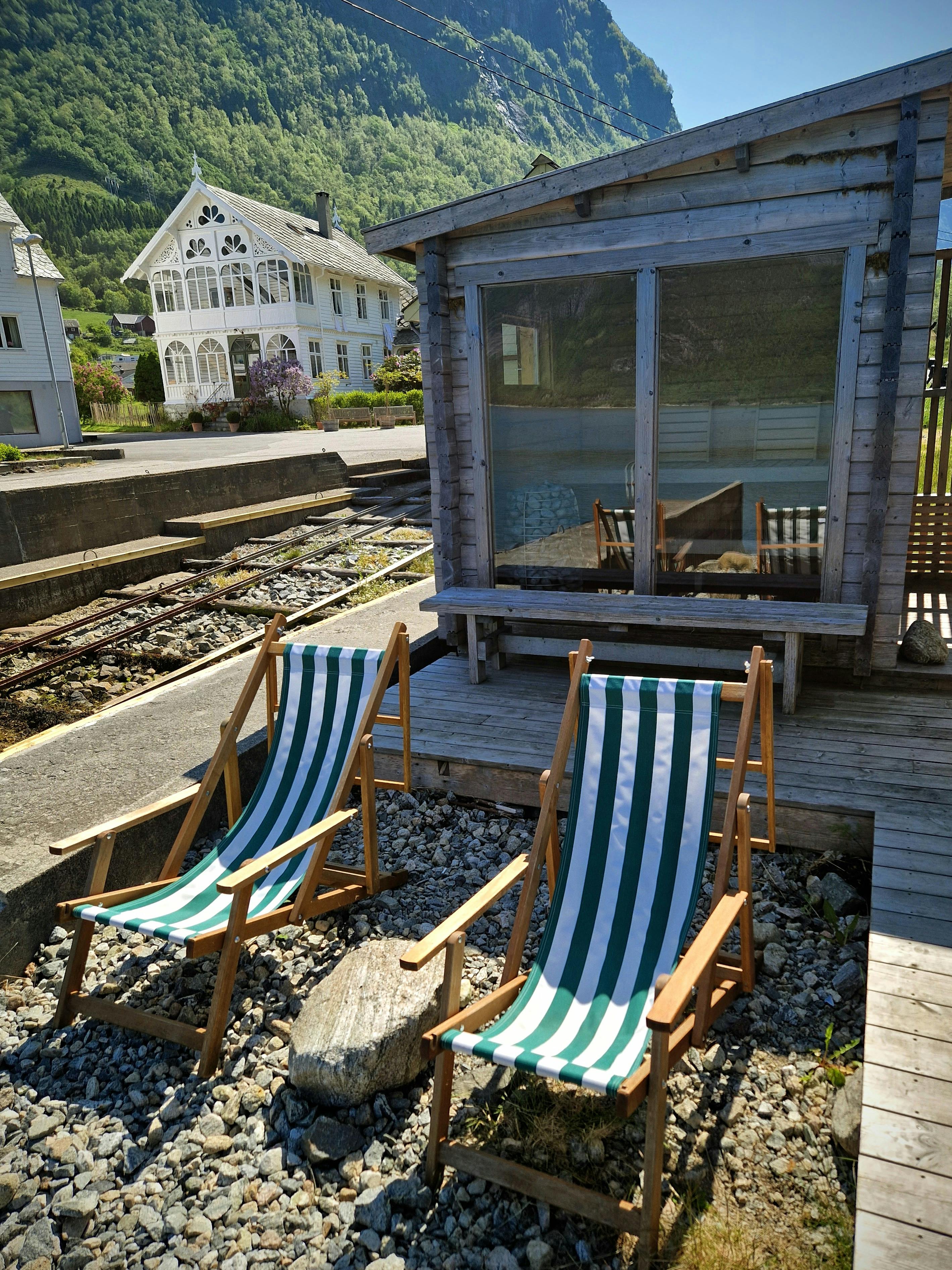 Deck Chairs in front of a Small Wooden Hut · Free Stock Photo