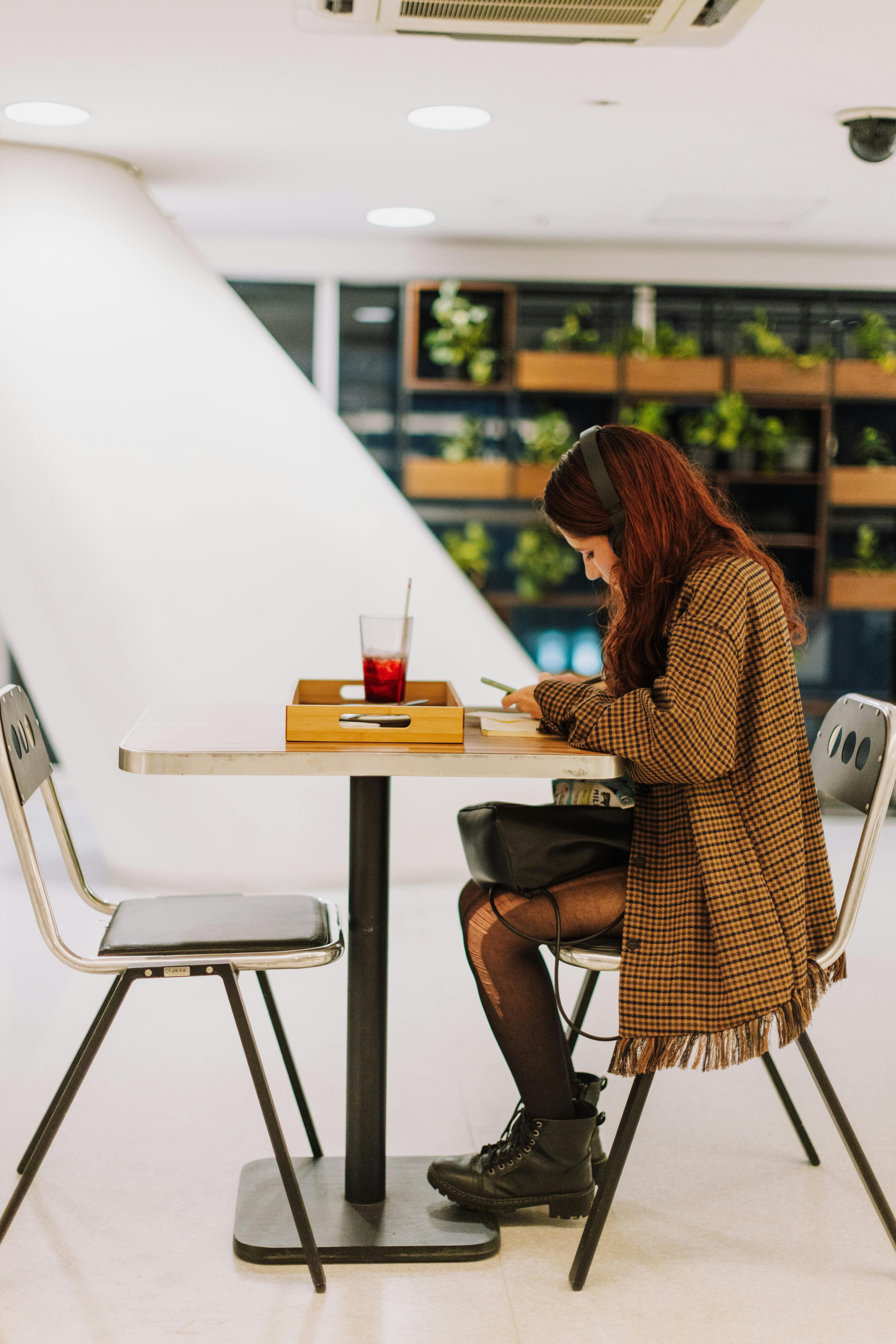 Young Woman Sitting alone at the Table in a Cafe · Free Stock Photo