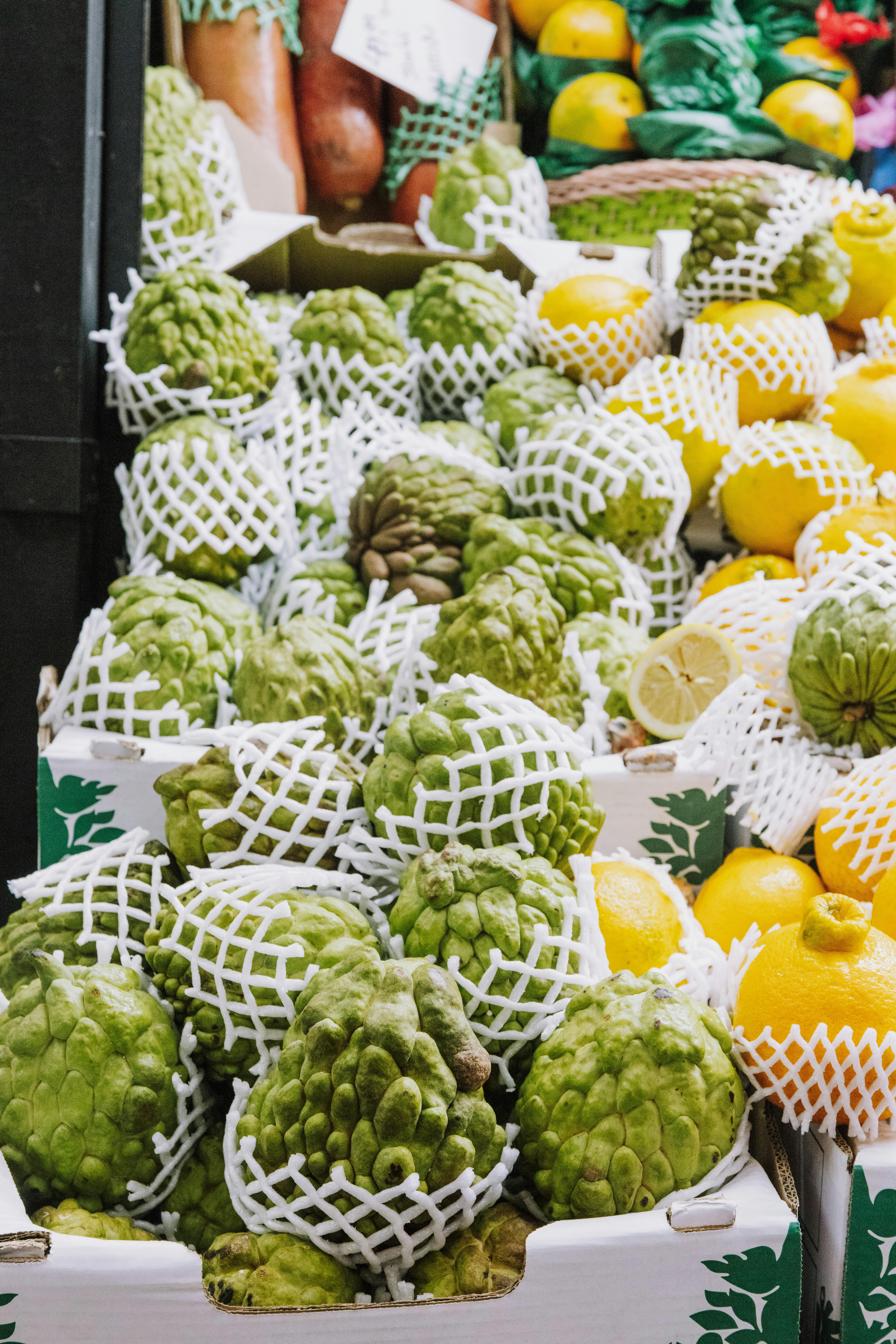 Porter Carrying Heavy Vegetables on Back at Bazaar · Free Stock Photo