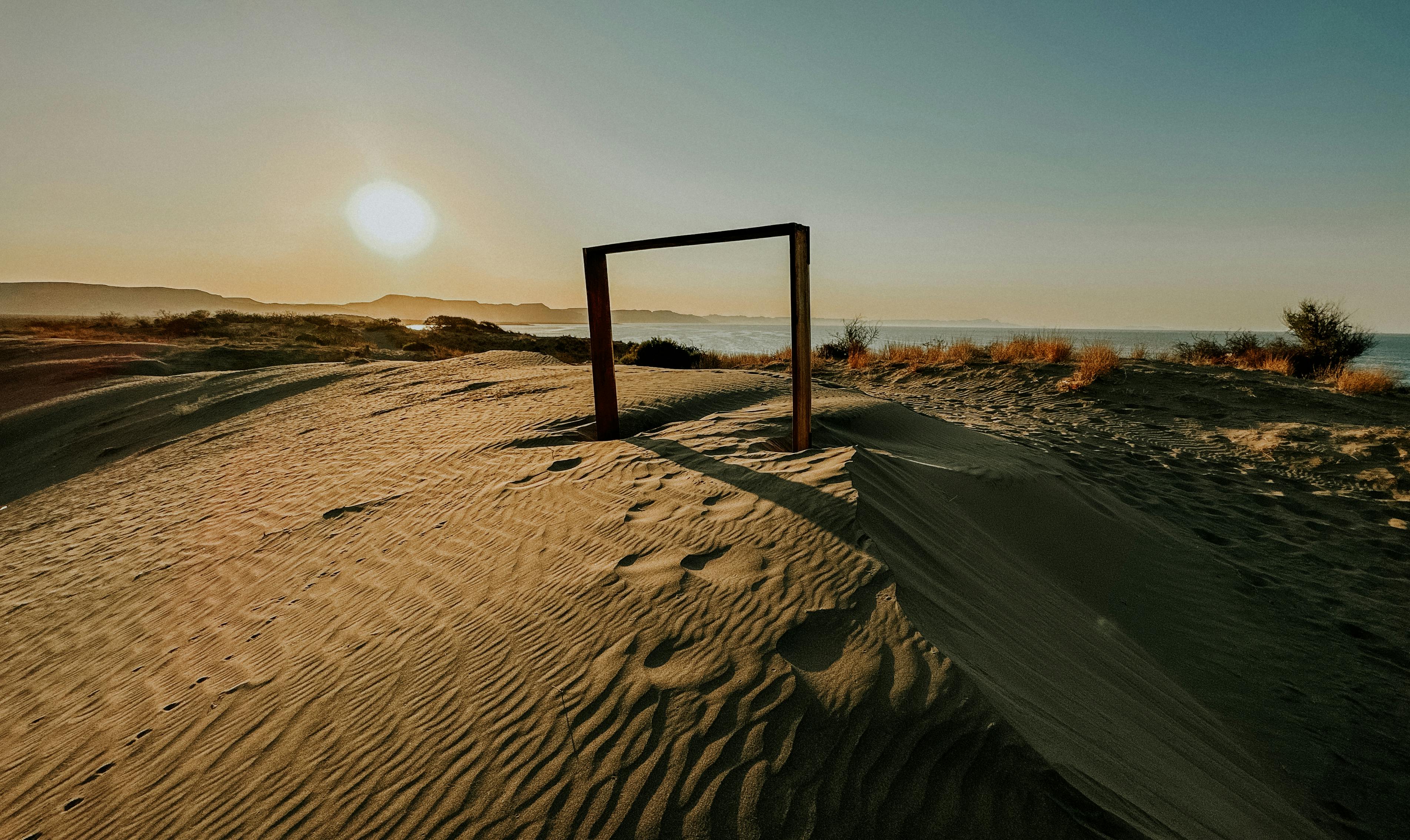 Sun over Frame on Sand Dune on Sea Coast · Free Stock Photo