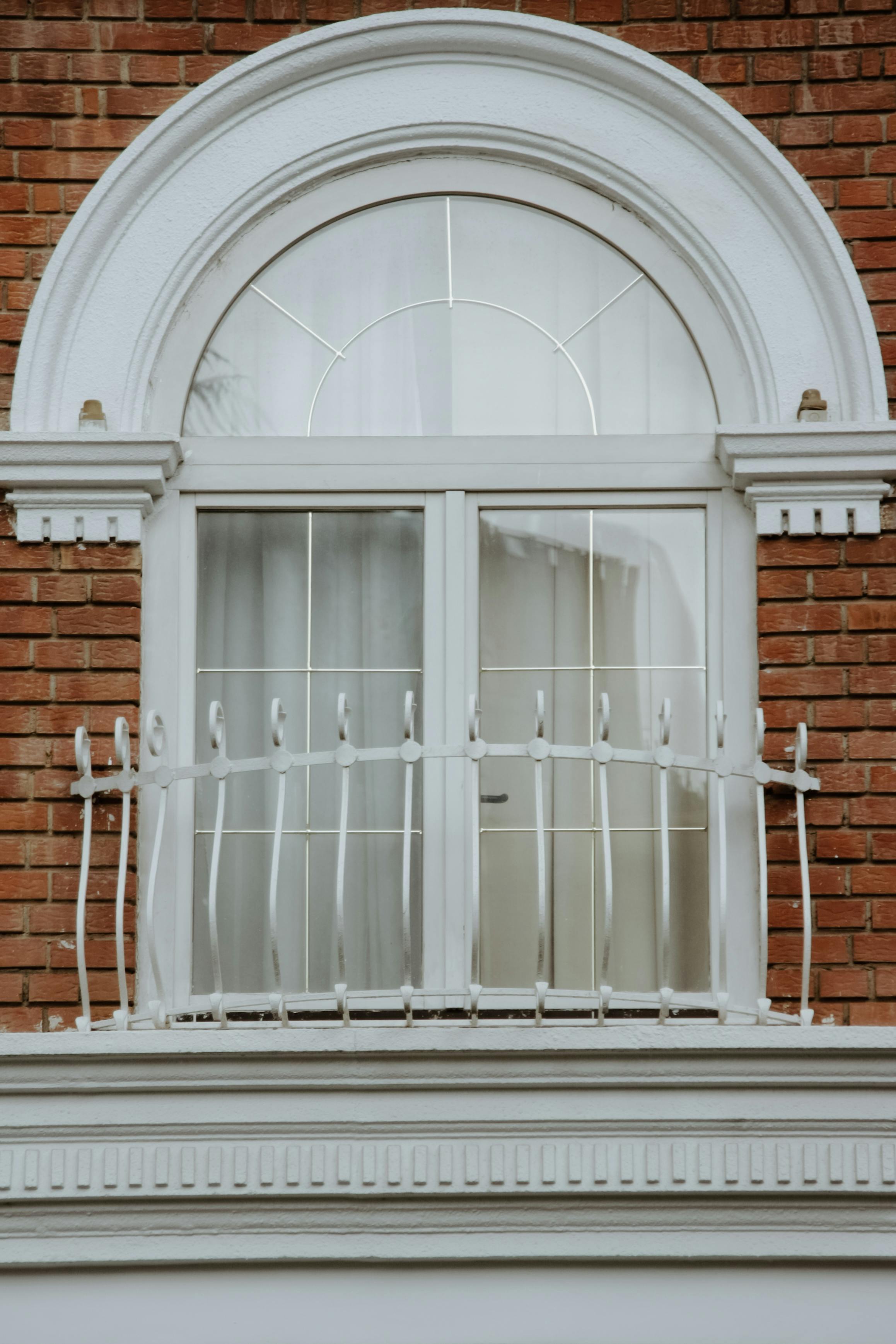 A window with a white railing and a white window · Free Stock Photo