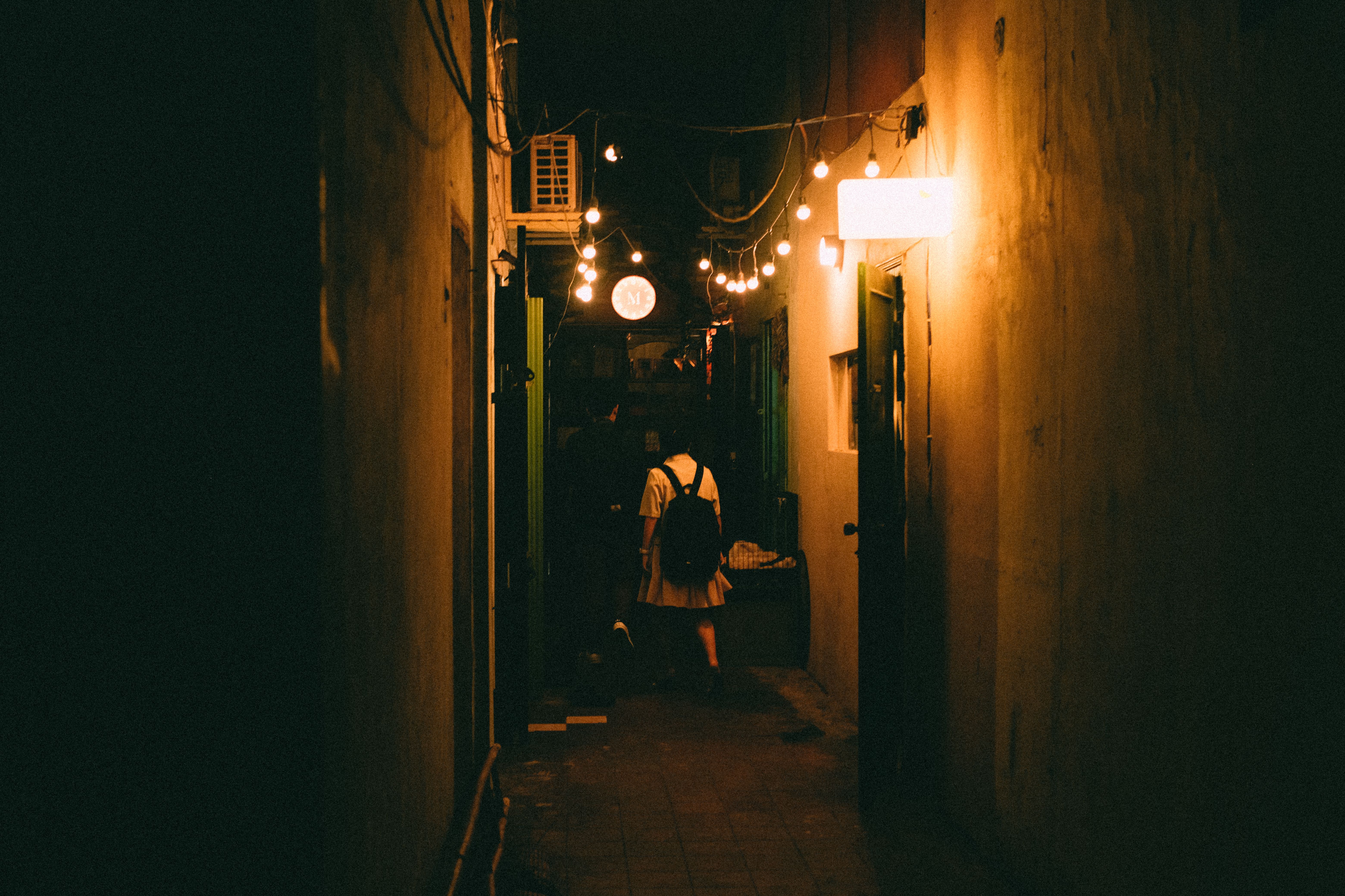 View of a Narrow Illuminated Alley between Buildings in City at Night ...