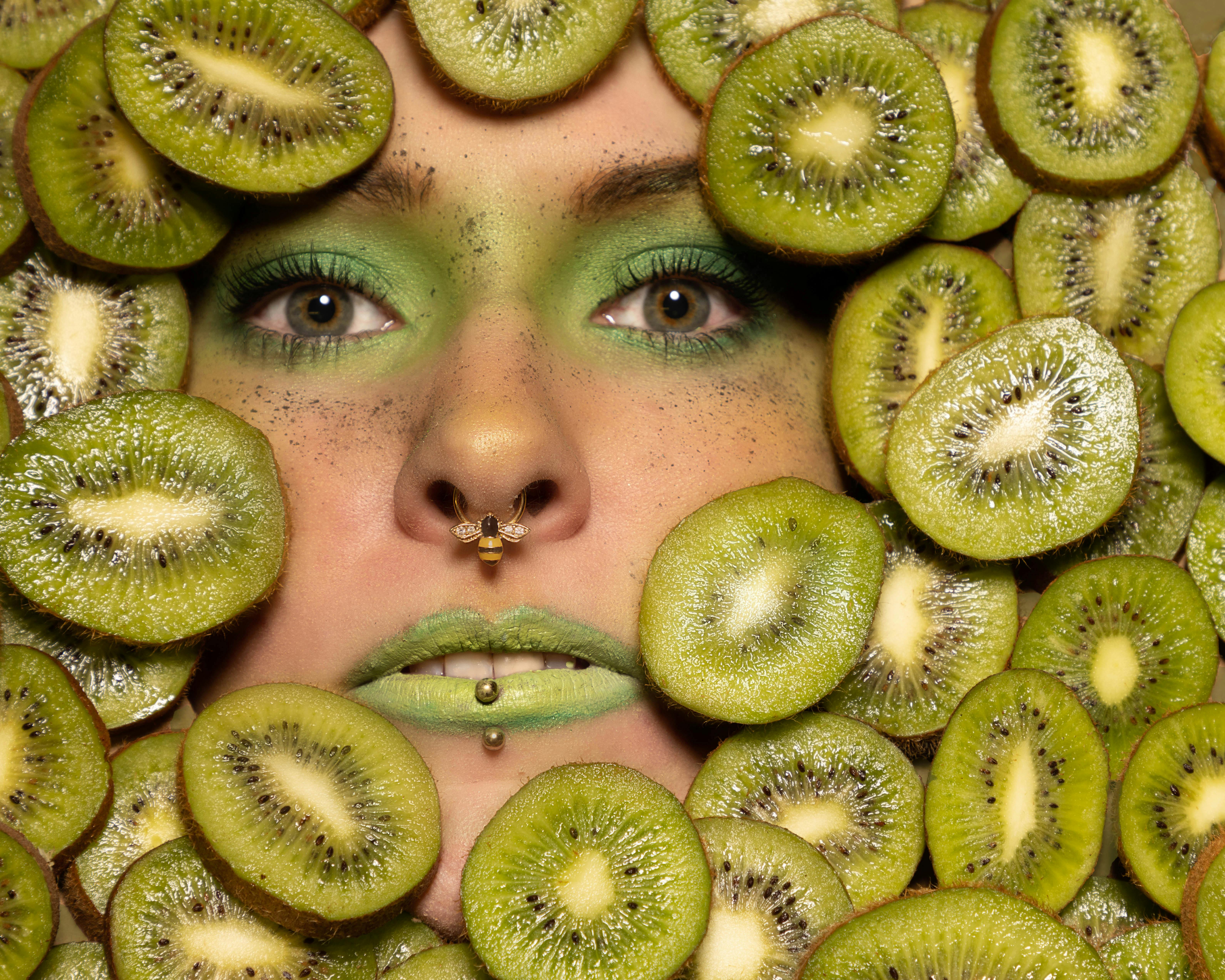 Portrait of a Woman Among Kiwis · Free Stock Photo