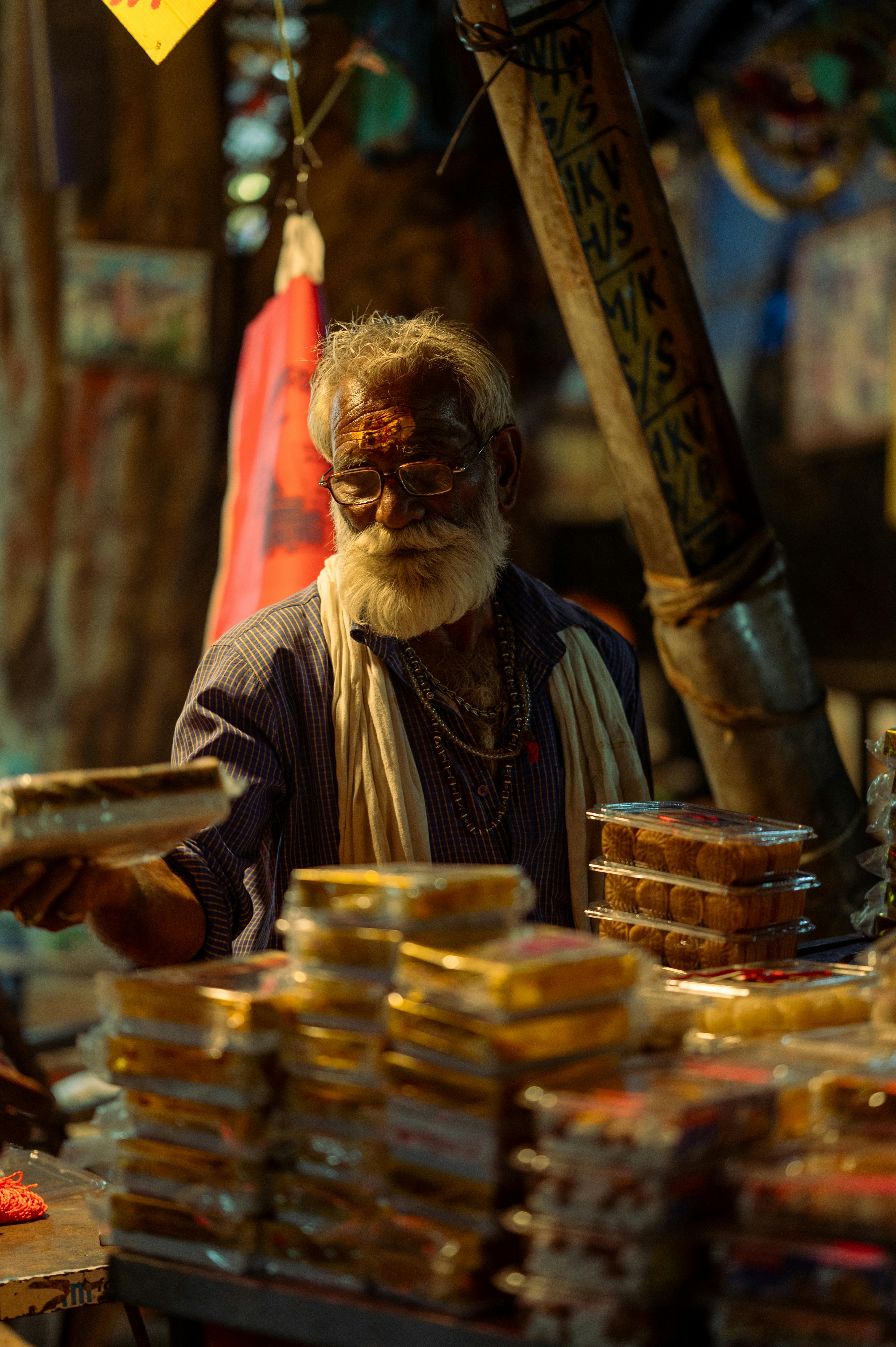 Elderly Man Working at Bazaar · Free Stock Photo