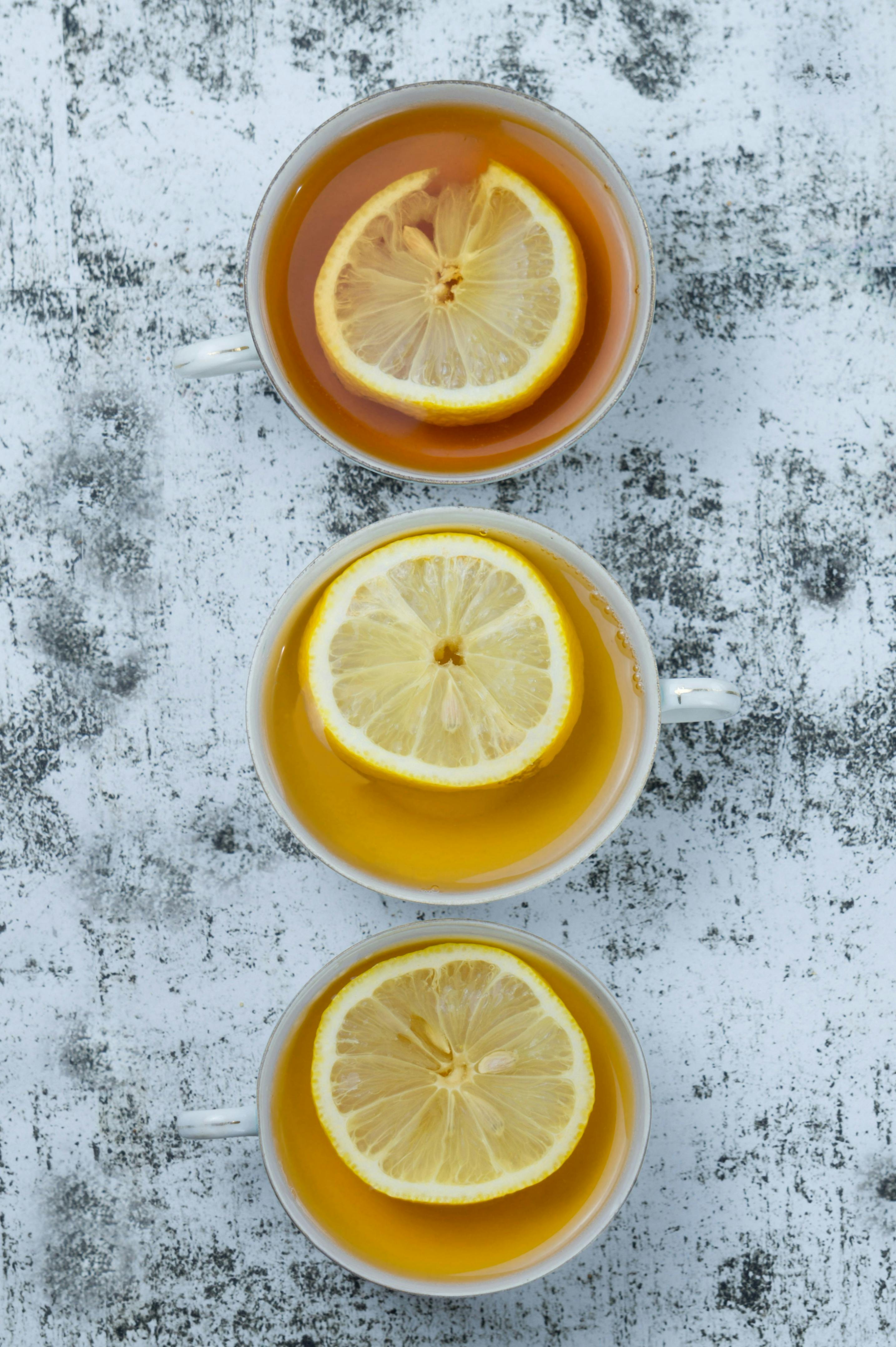 Three cups of tea with lemon slices and tea bags · Free Stock Photo