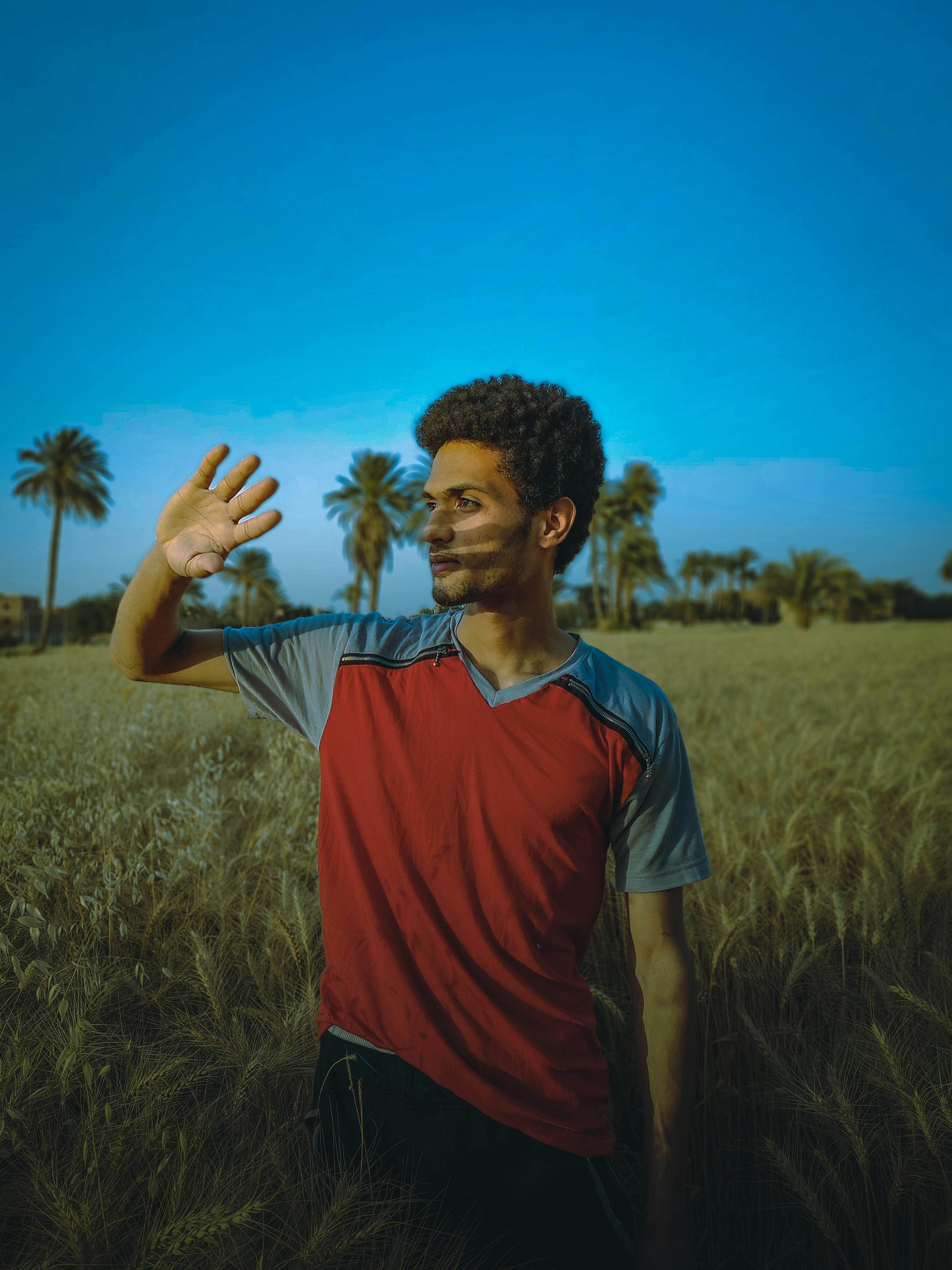 Man Wearing Red Shirt on a Sunny Field · Free Stock Photo