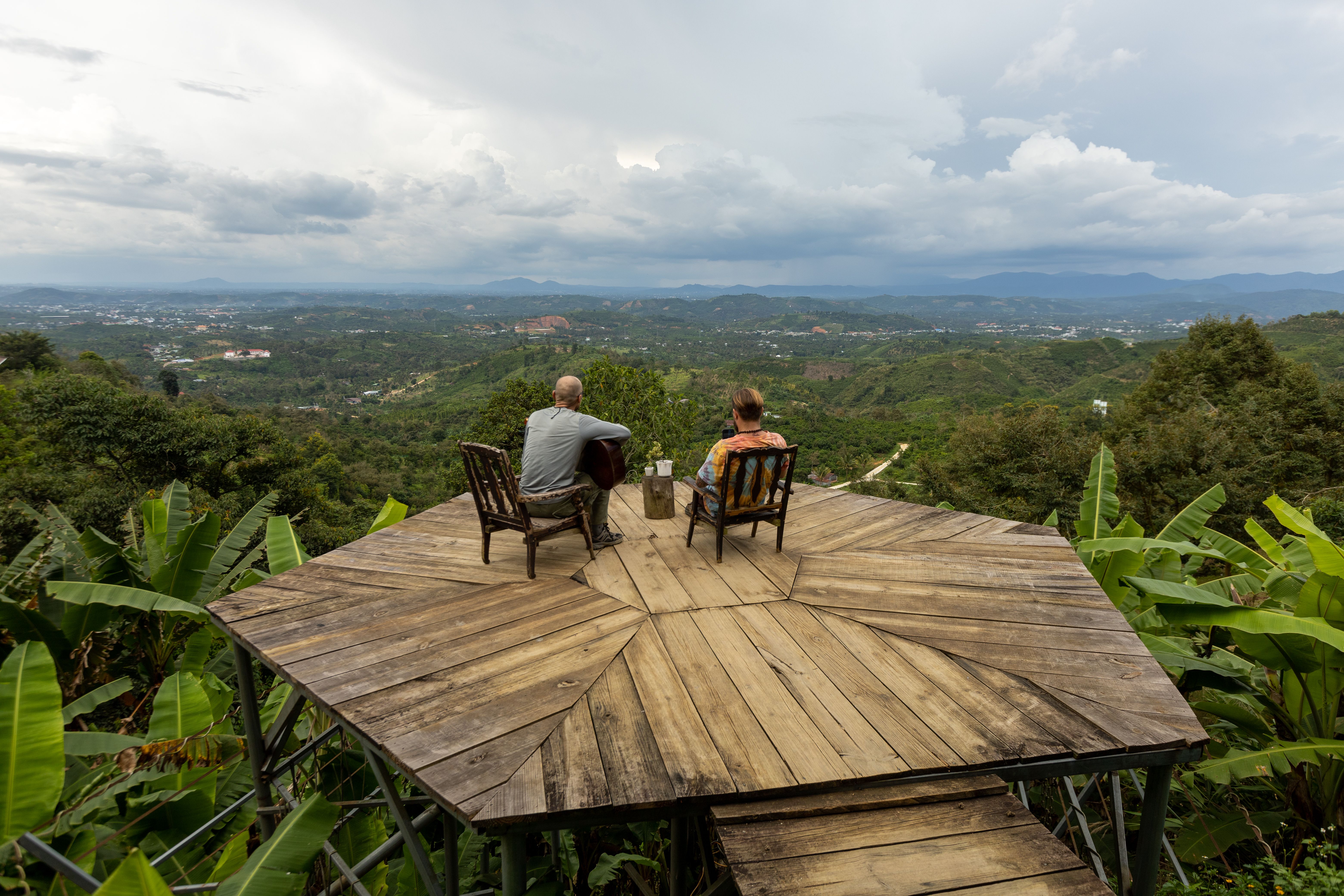 Men Sitting on Terrace over Forest · Free Stock Photo