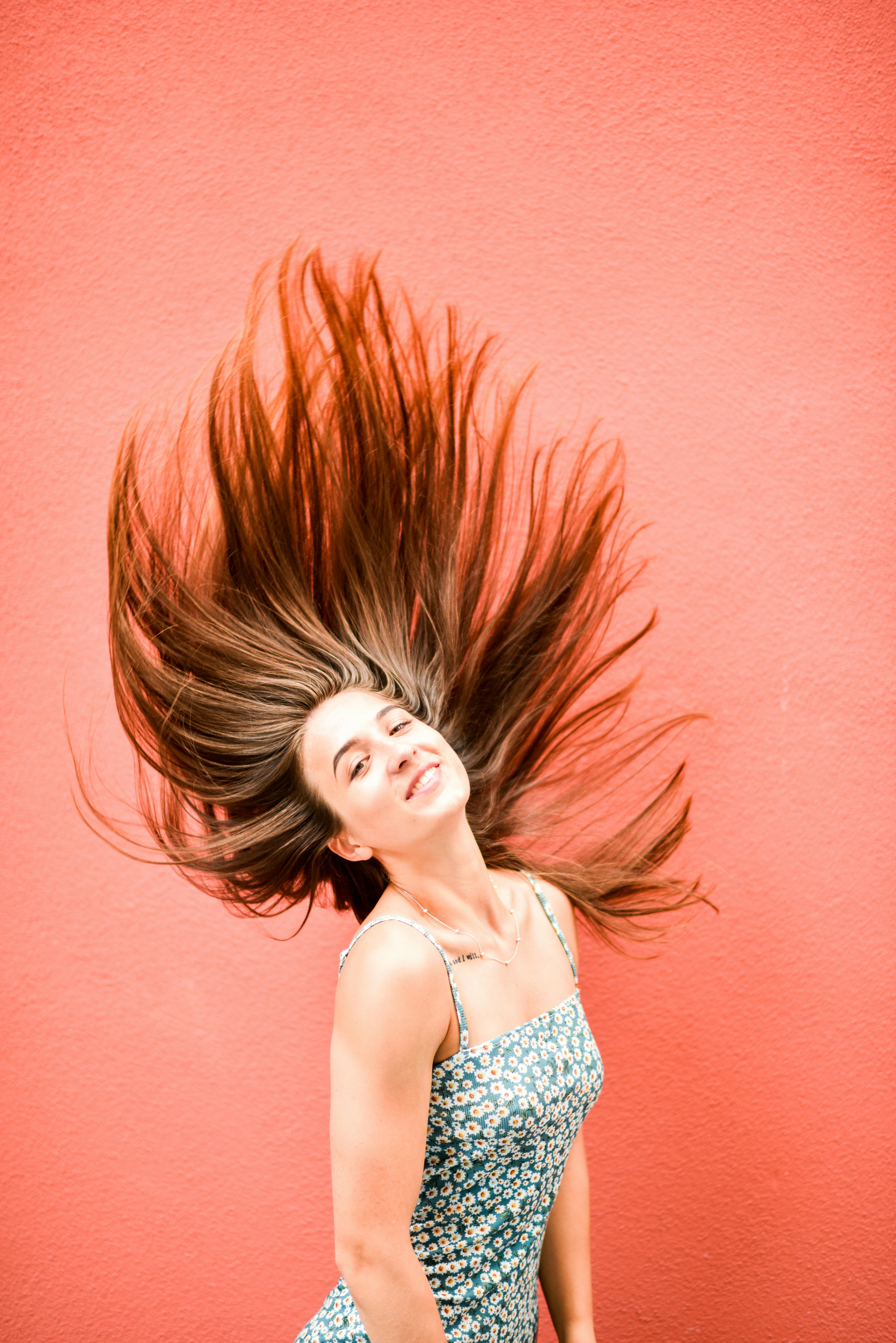 Smiling Woman with Hair Raised Up · Free Stock Photo