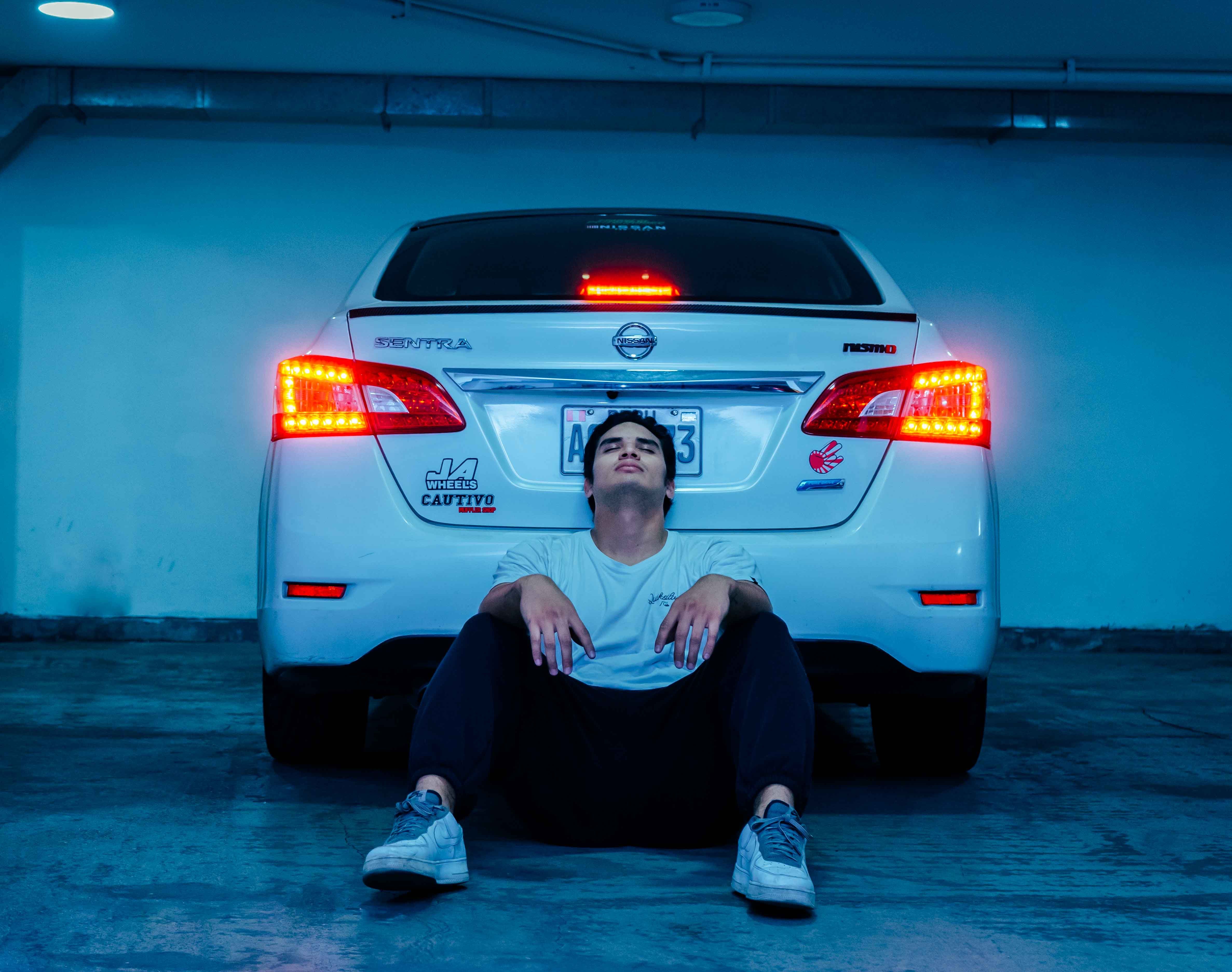 Man Leaning against White Car · Free Stock Photo