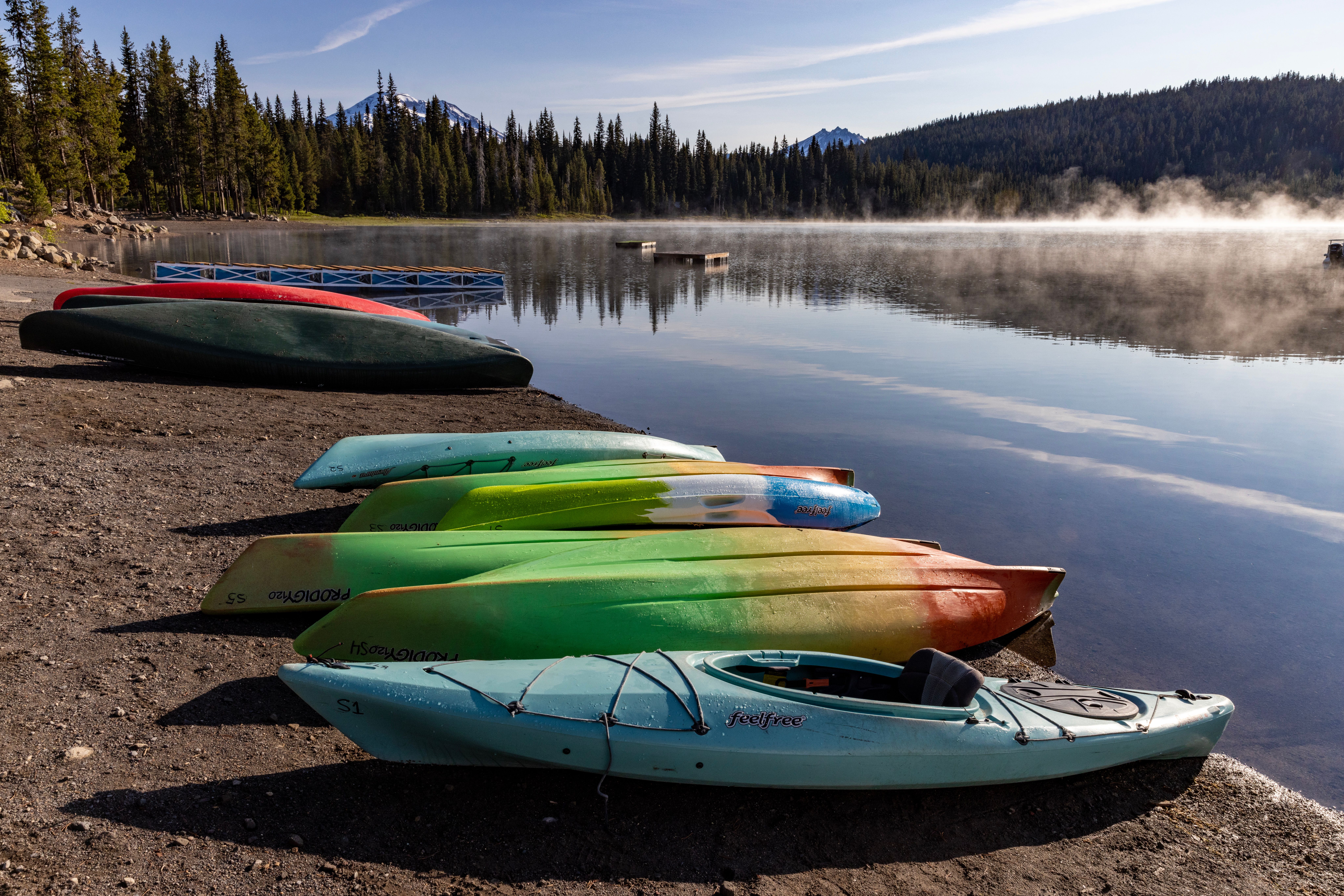 Colorful Canoes on Lakeshore · Free Stock Photo