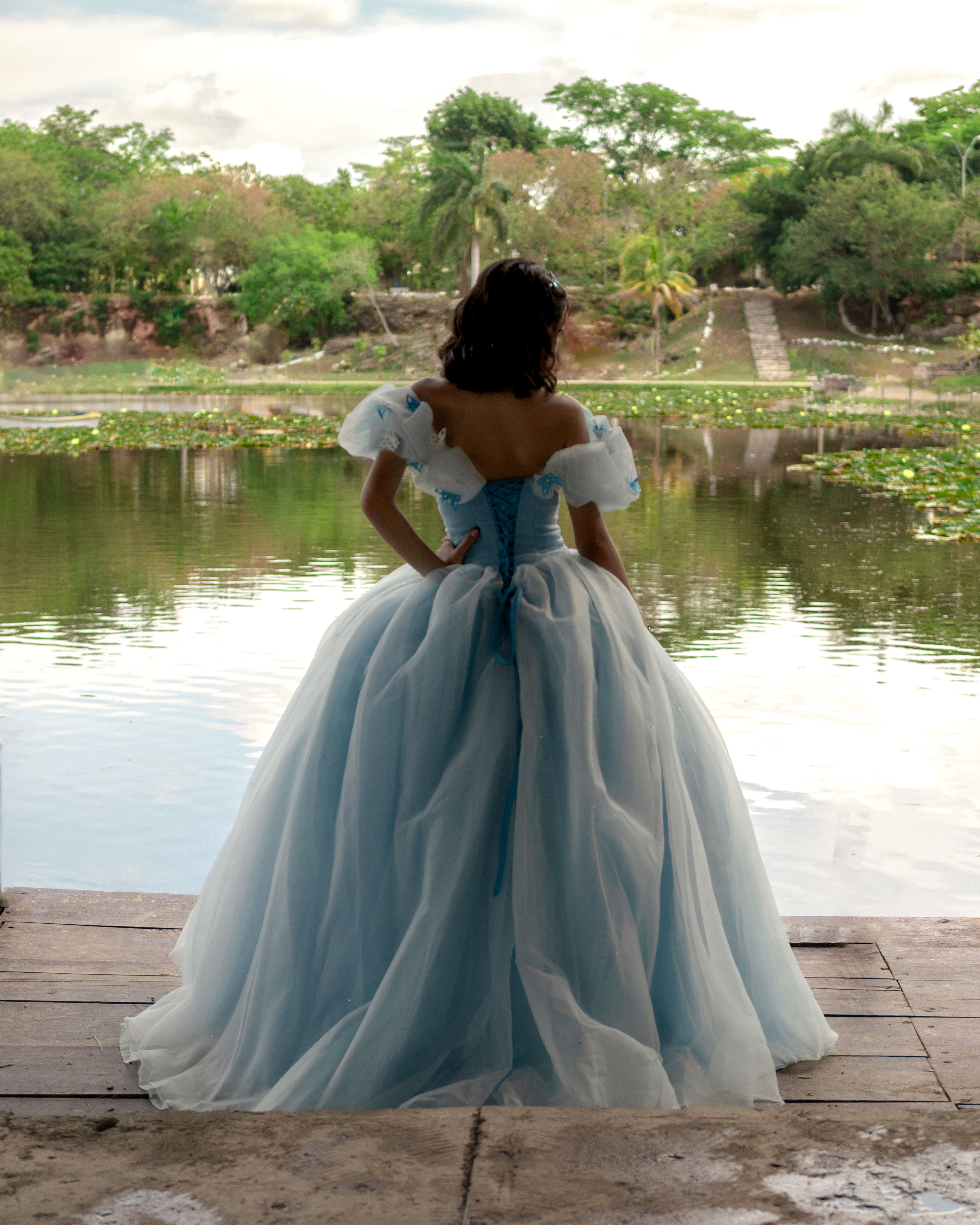 Brunette Woman in Blue Dress Standing by River · Free Stock Photo