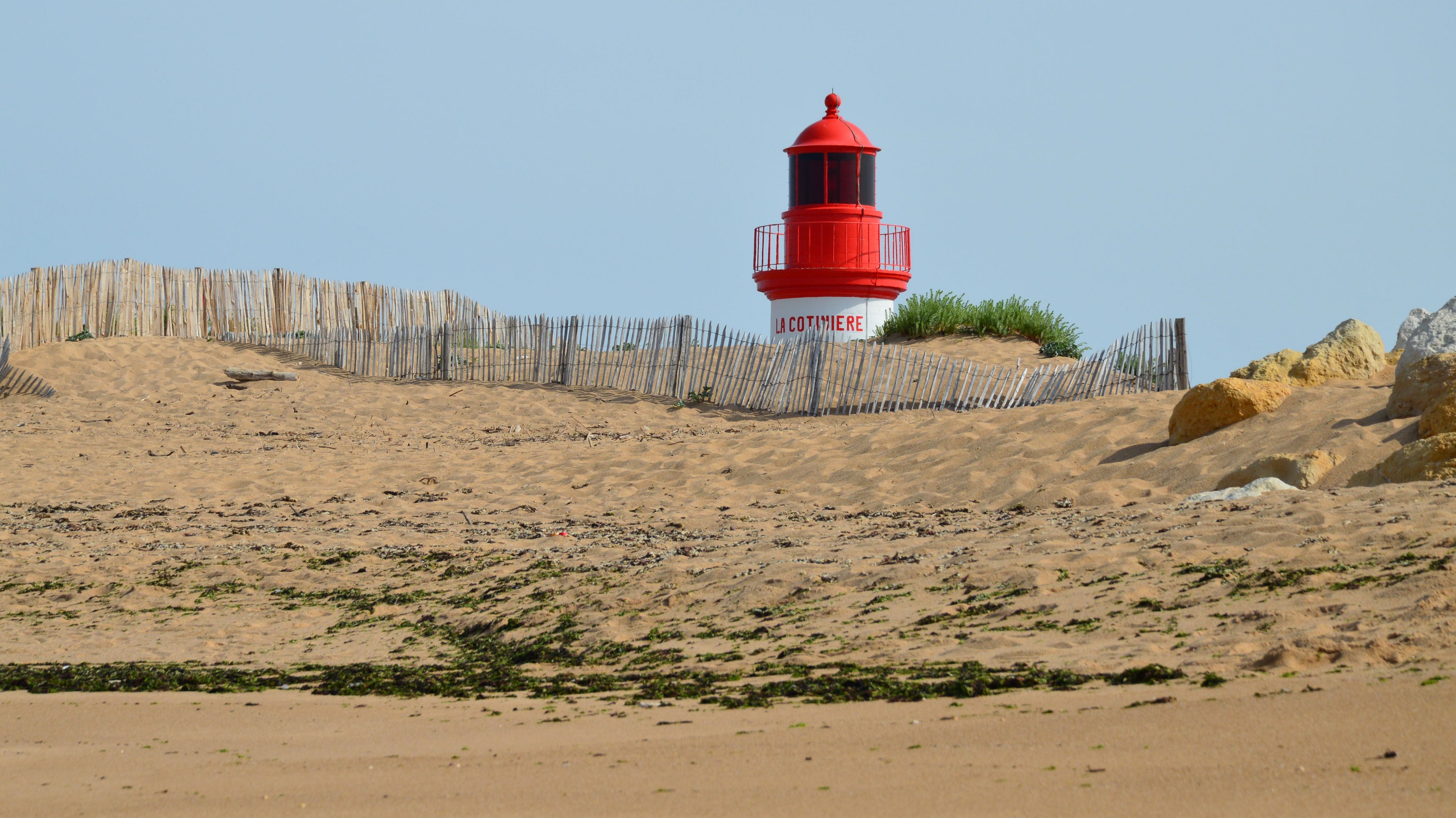 Beach with Lighthouse · Free Stock Photo