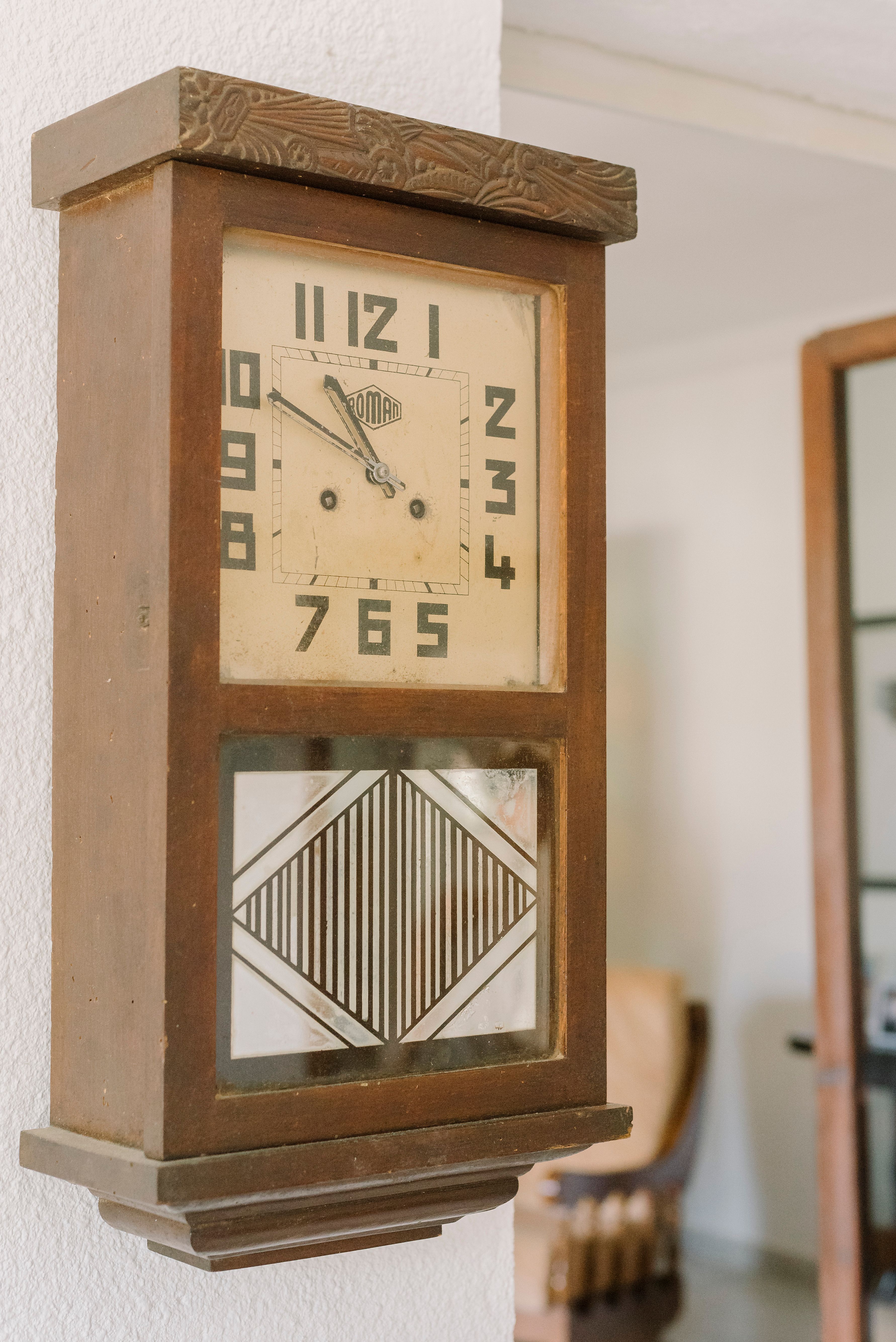 An Antique Clock Hanging on the Wall · Free Stock Photo