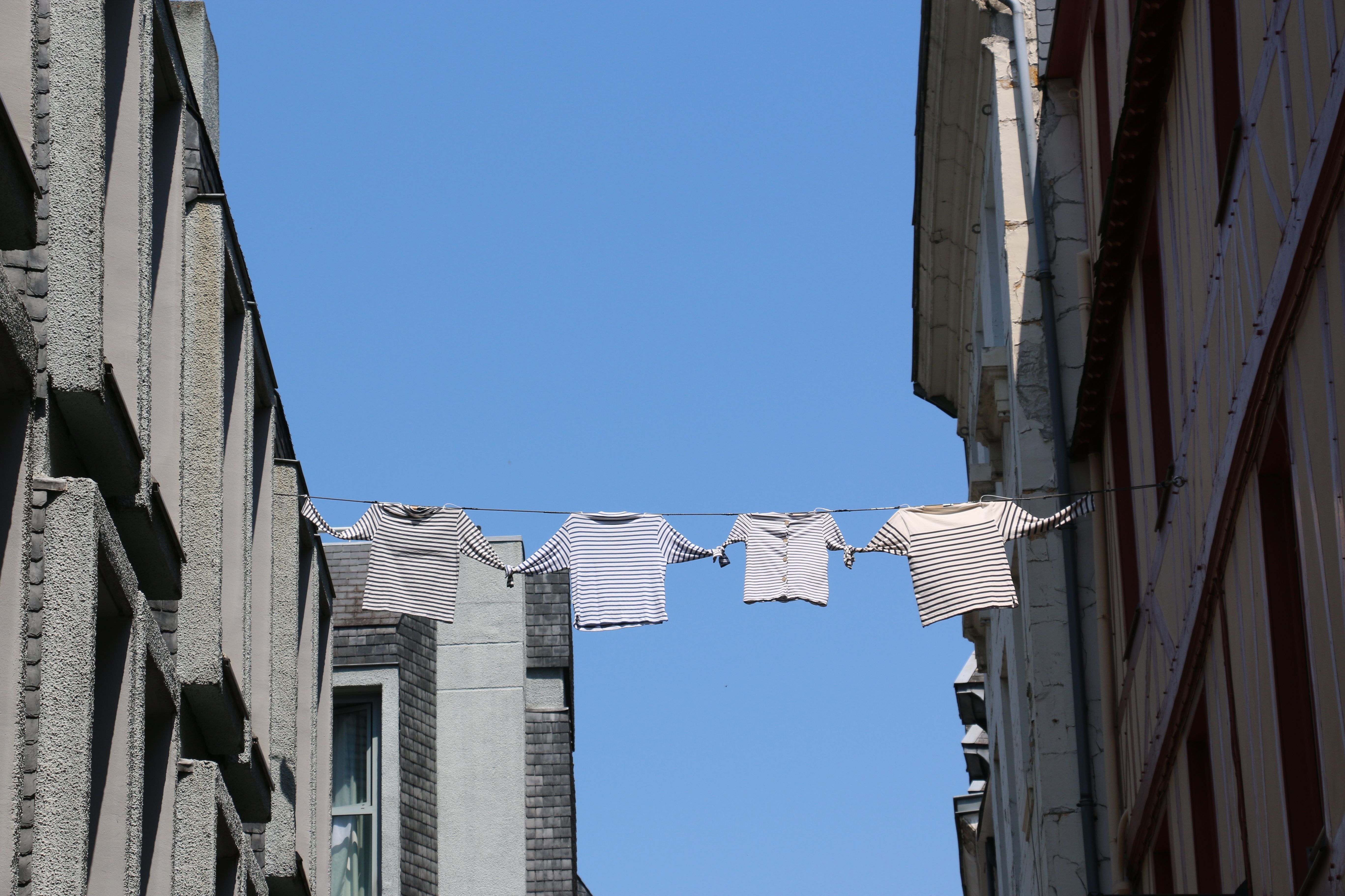 Clothes Drying on String over Alley in Town · Free Stock Photo