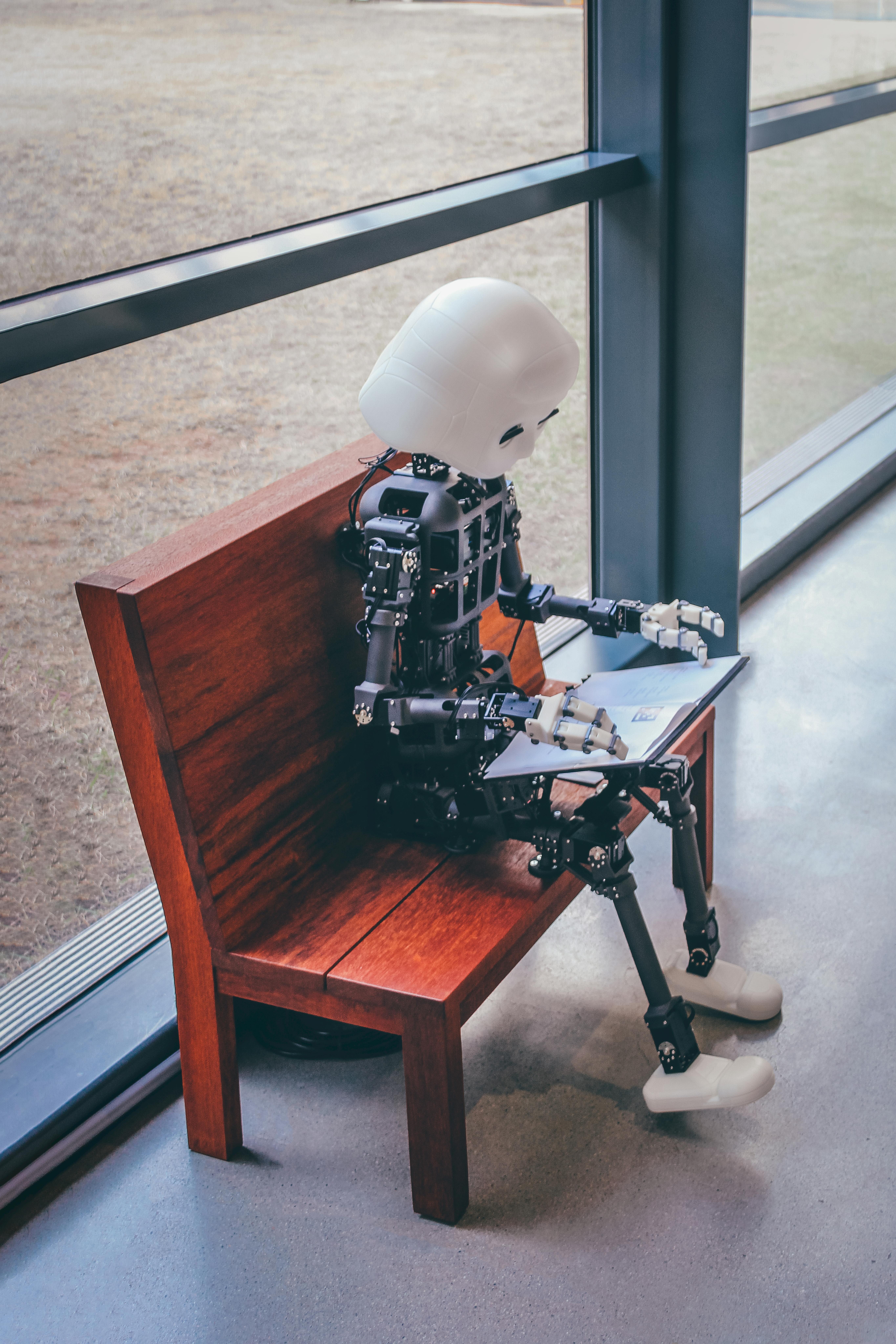 Robot Sitting on Bench · Free Stock Photo