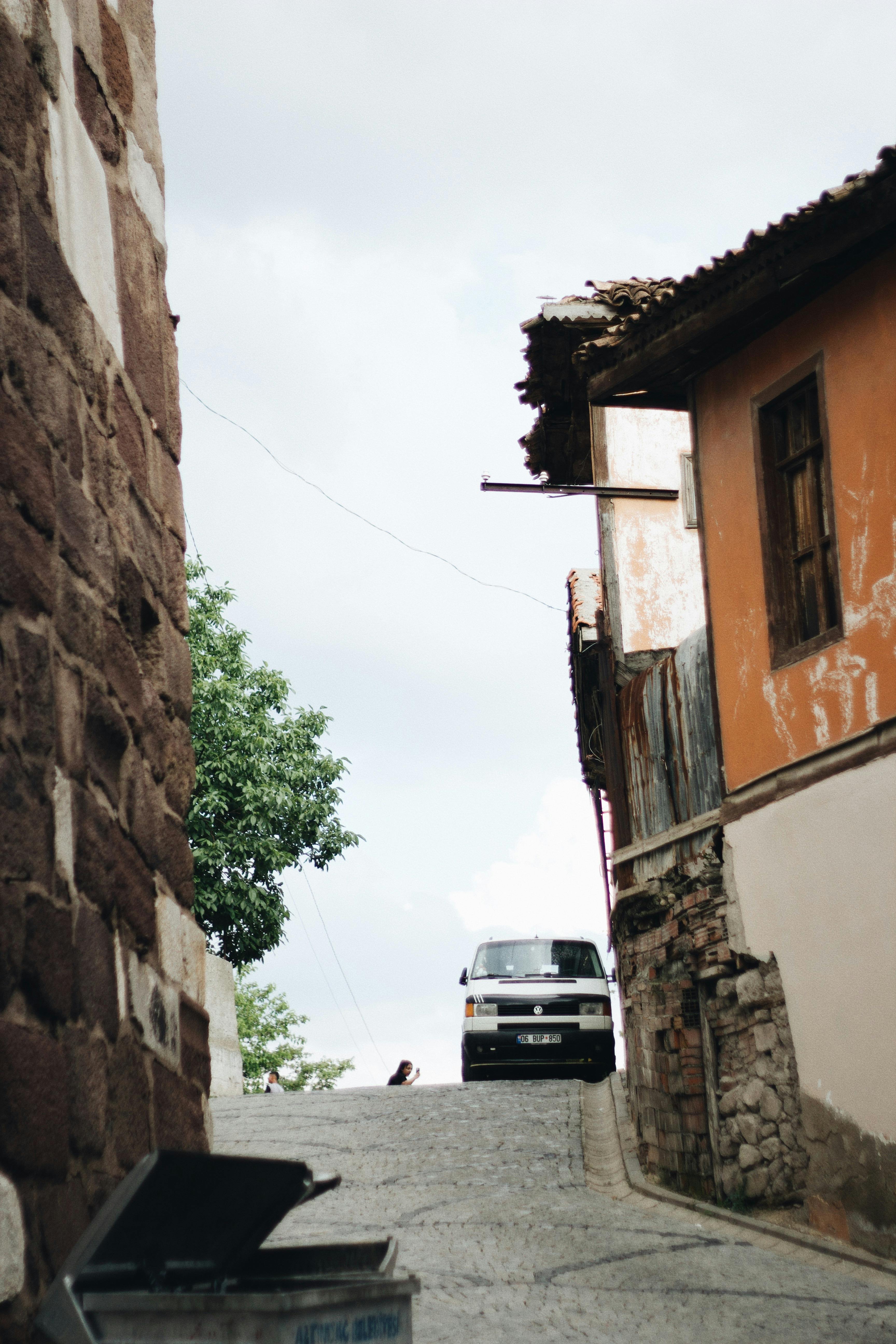 Orange Bentley Mulsanne Parked in a Narrow Steep Alley · Free Stock Photo