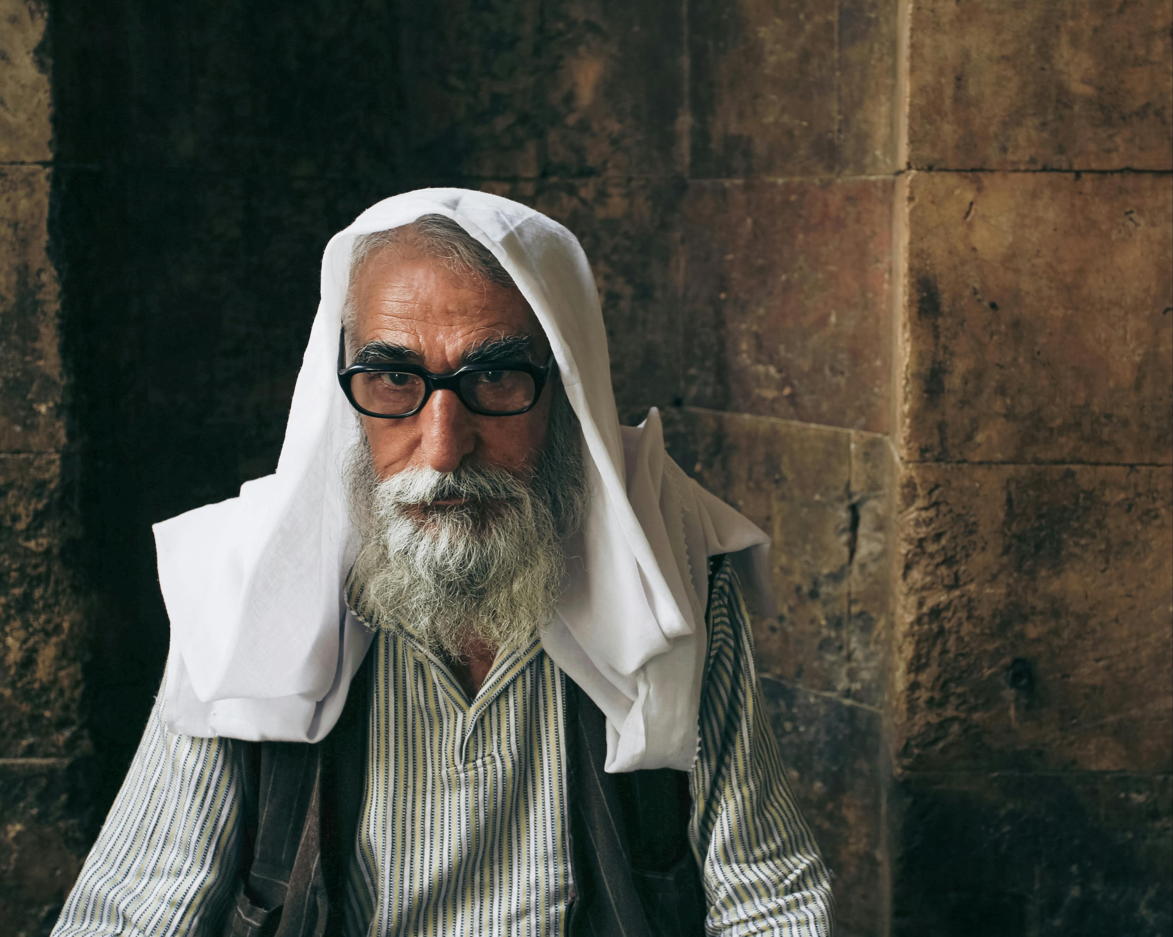 Elderly Man Filling Metal Jars with Water · Free Stock Photo