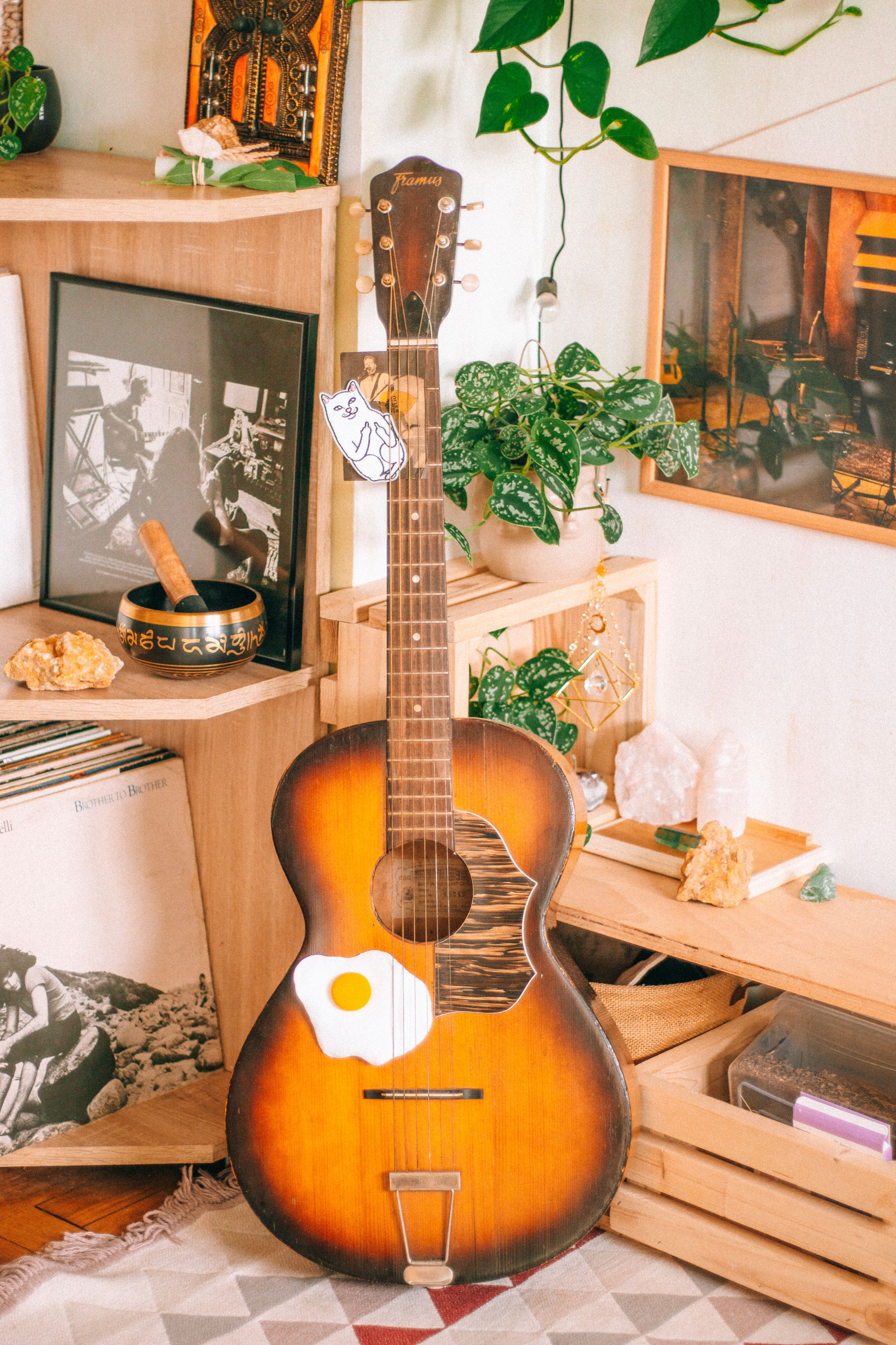 Brown Acoustic Guitar Leaning on Brown Velvet Couch · Free Stock Photo