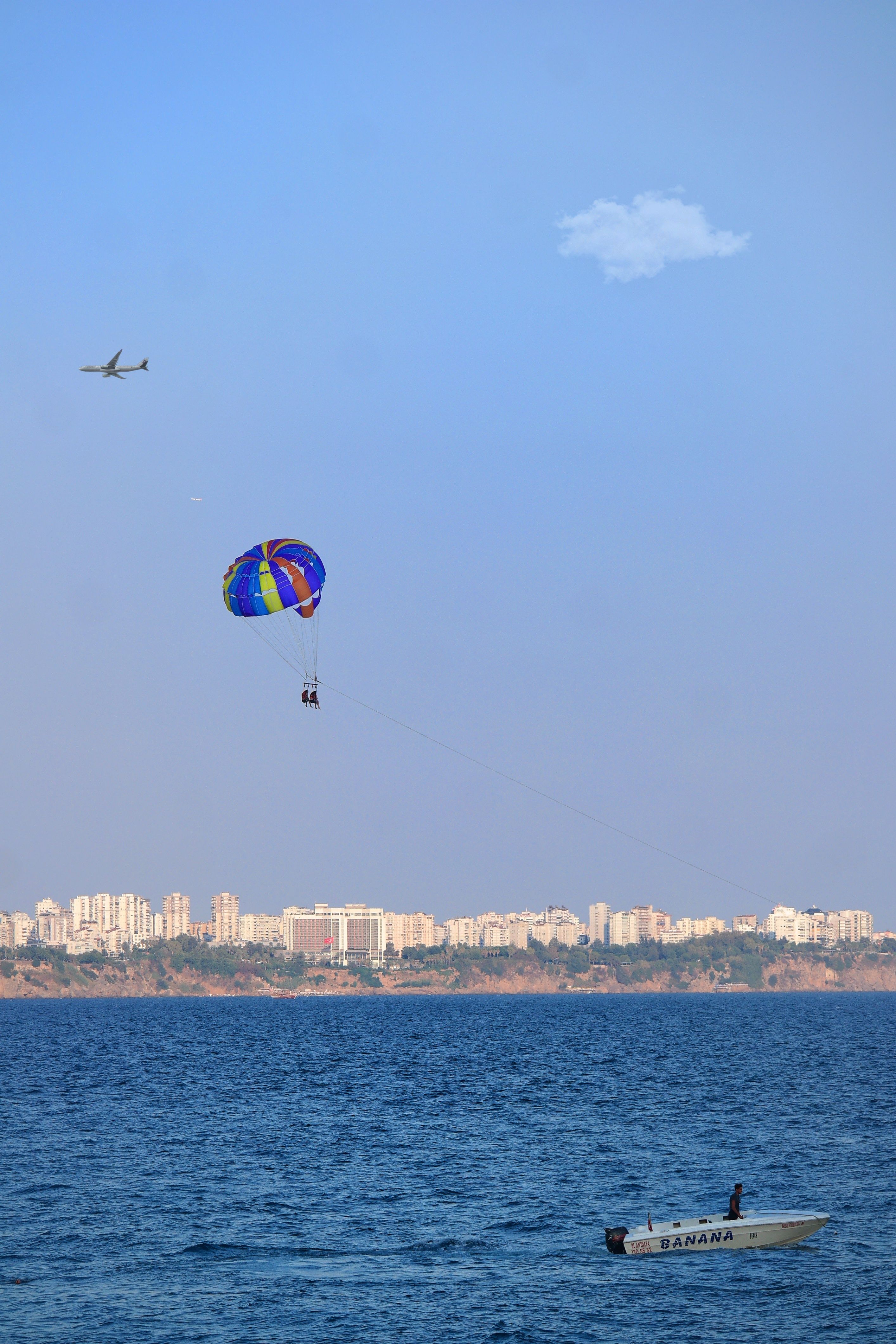 A Parachute over the Sea and Boat on the Sea near a Coast · Free Stock ...