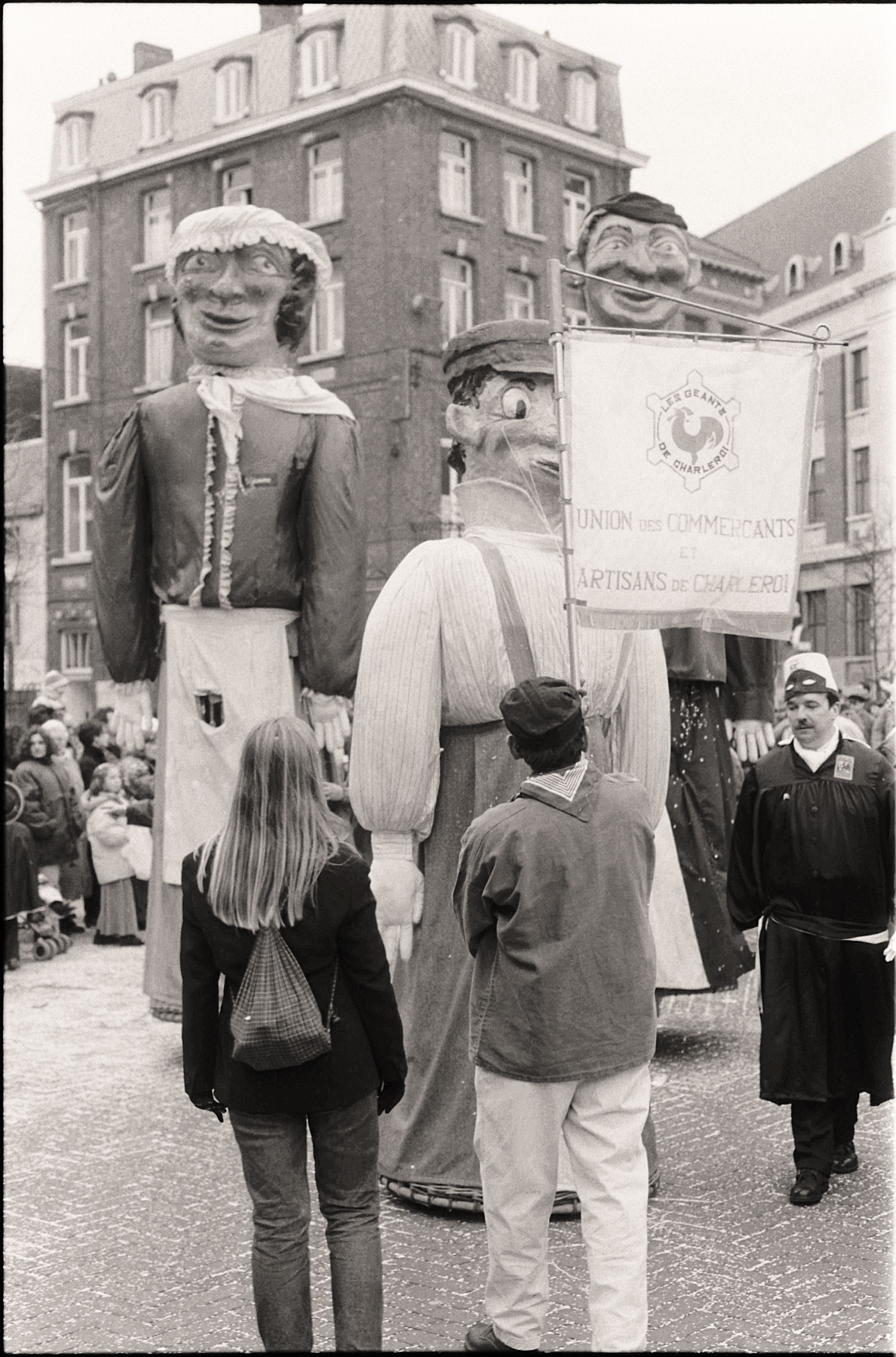 An Old Photograph of People in Costumes at a Parade on the Street ...
