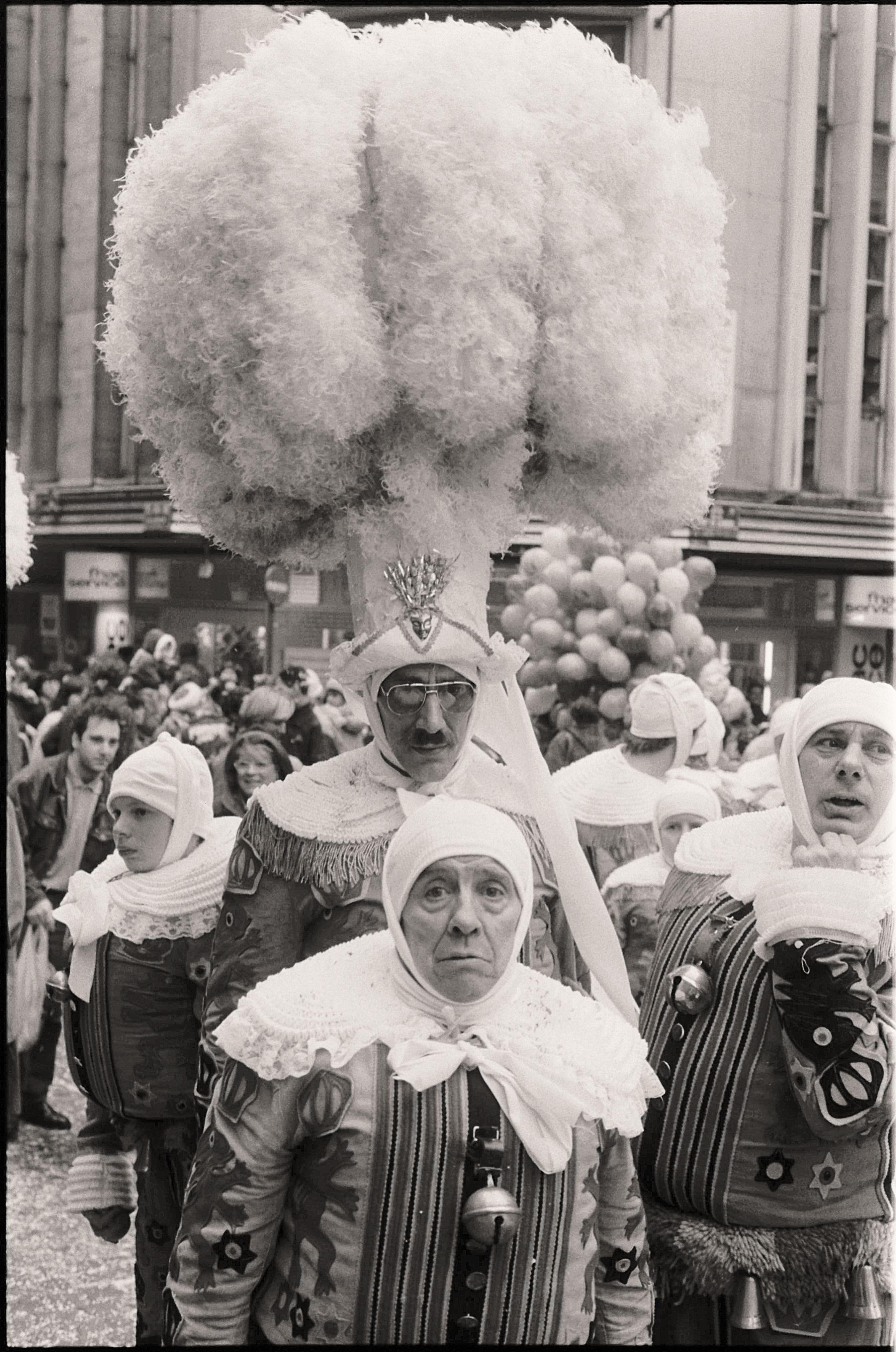An Old Photograph of People in Costumes at a Parade on the Street ...