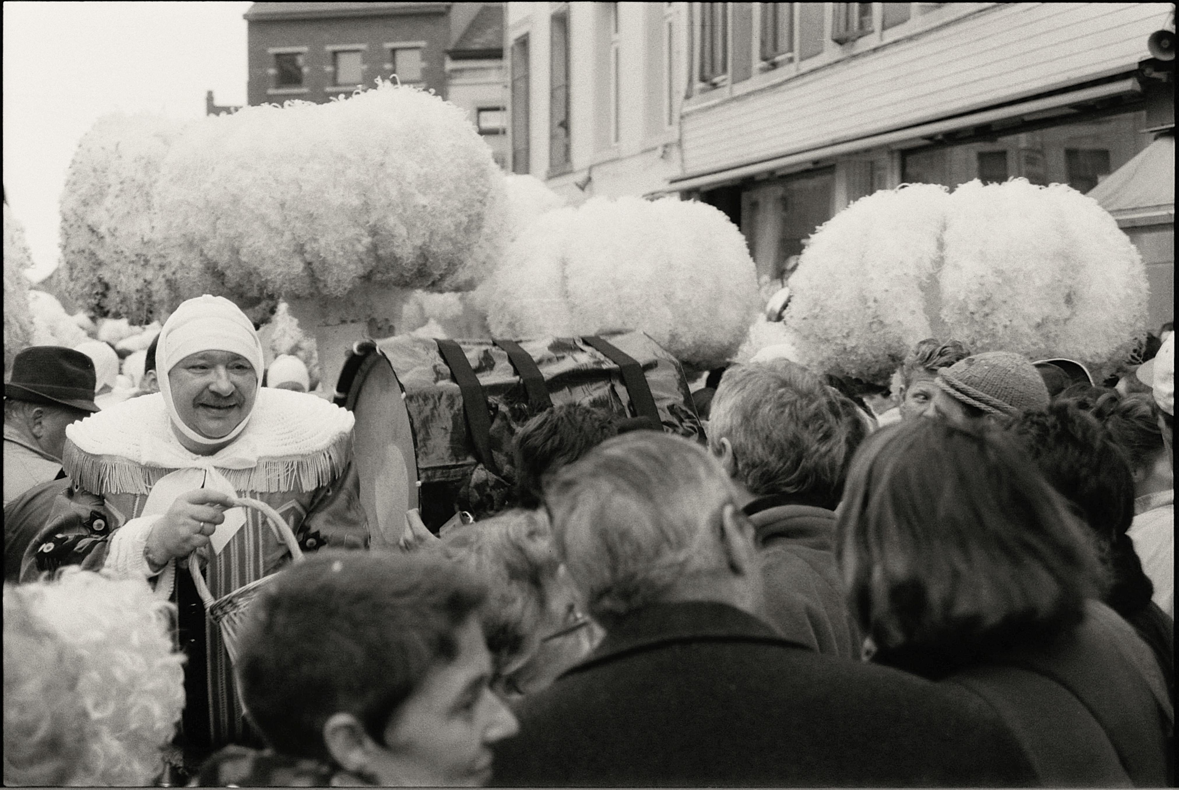 An Old Photograph of People in Costumes at a Parade on the Street ...