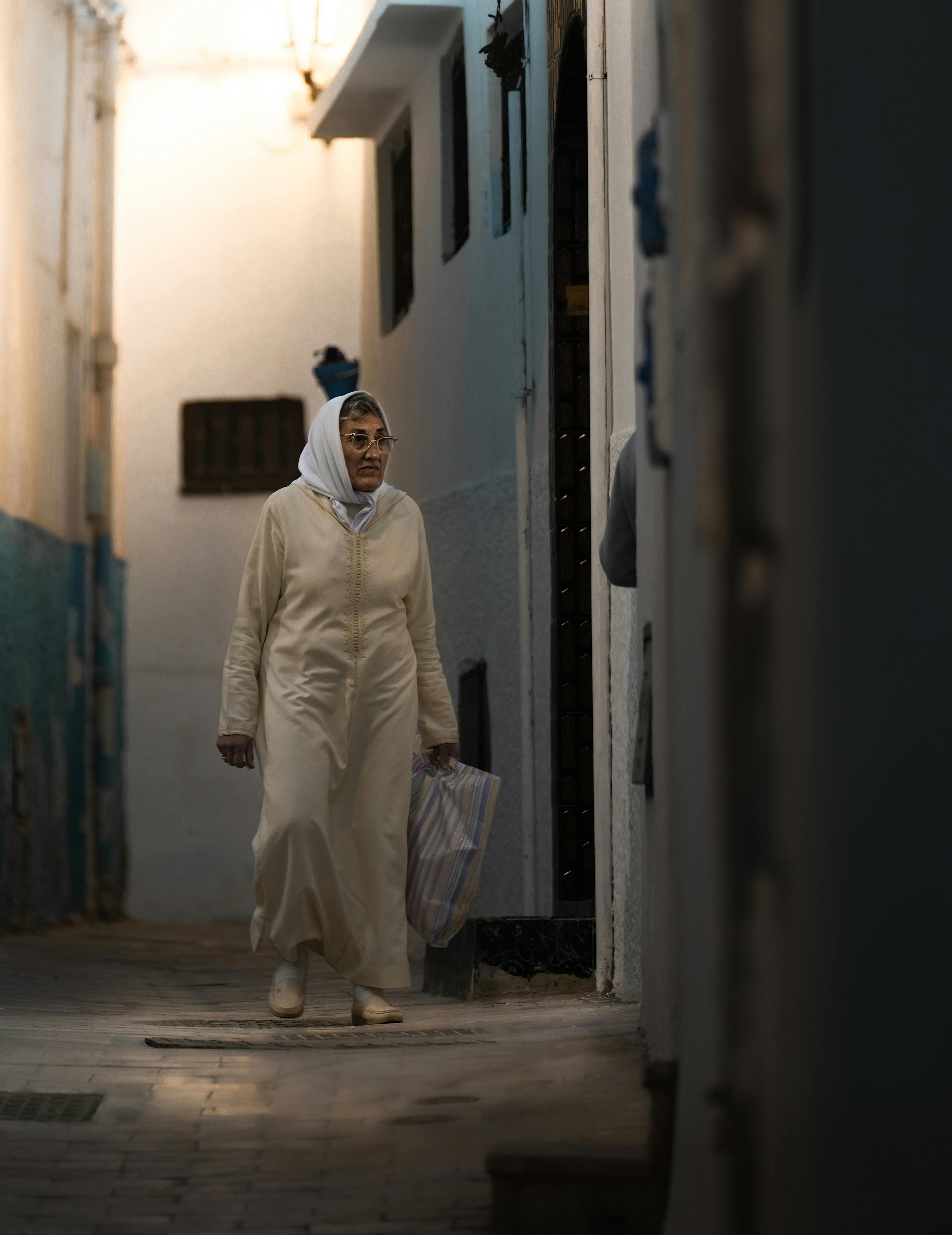 Woman Walking in Narrow Alley in Town · Free Stock Photo