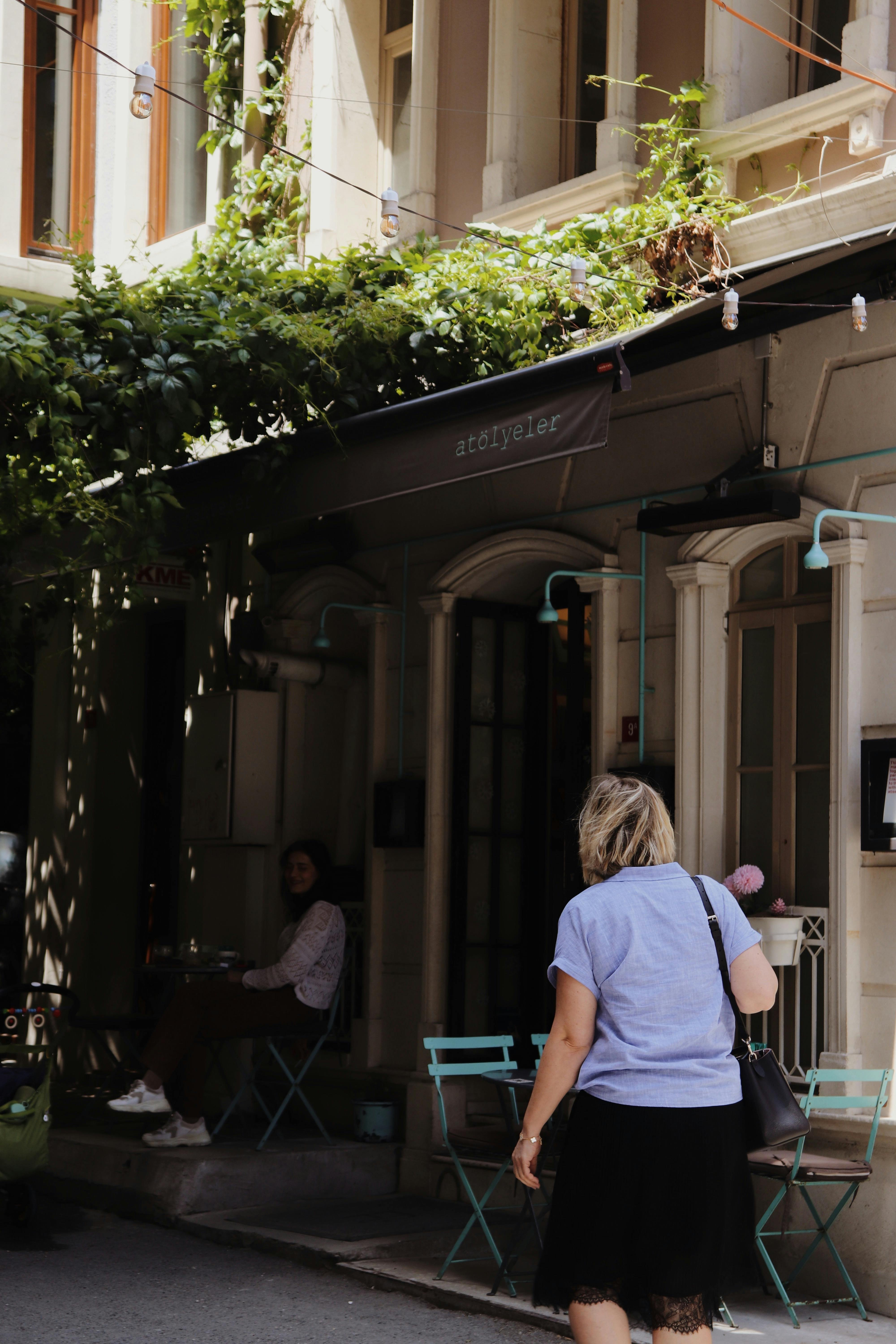Woman Walking near Building · Free Stock Photo