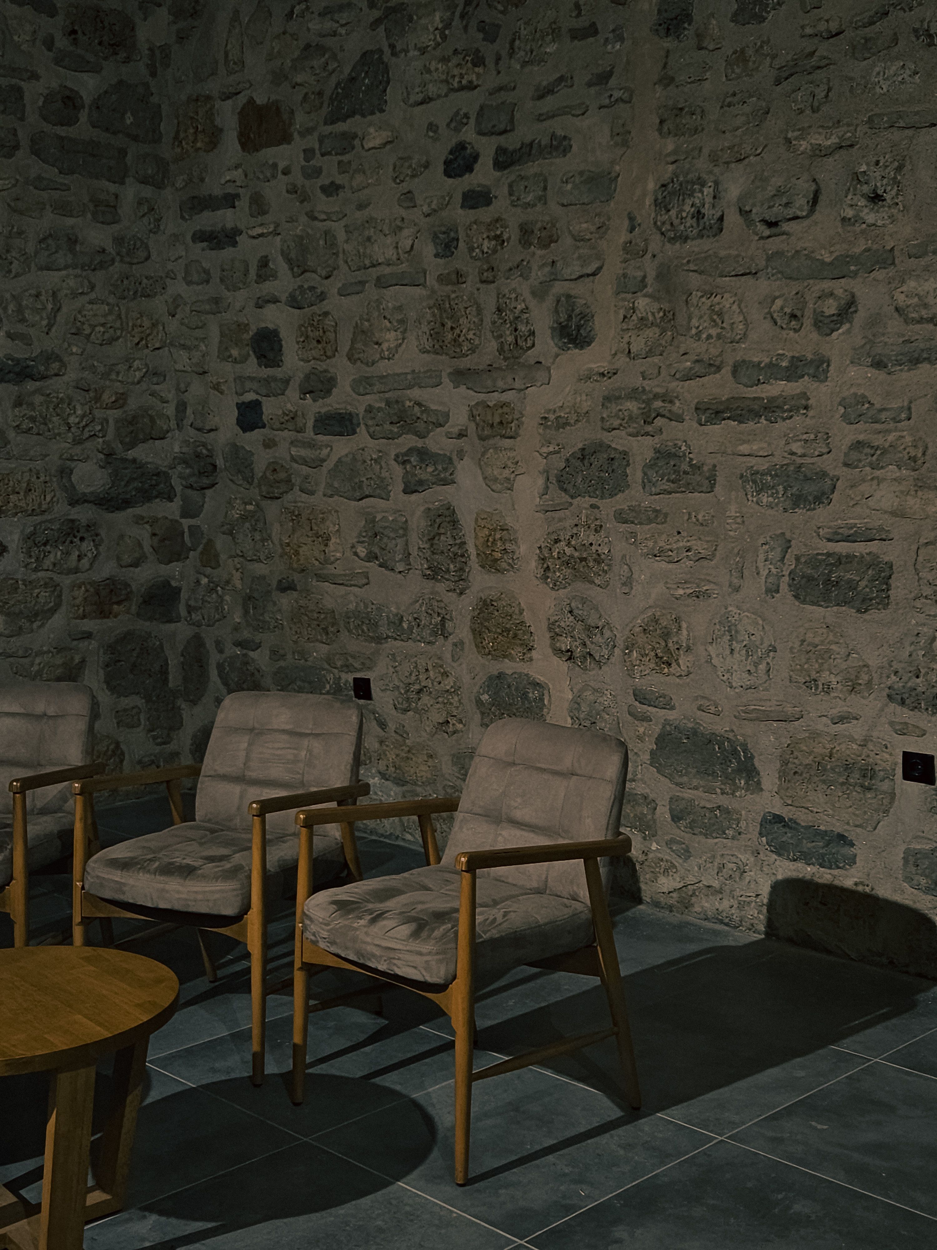 Stone Wall behind Chairs · Free Stock Photo
