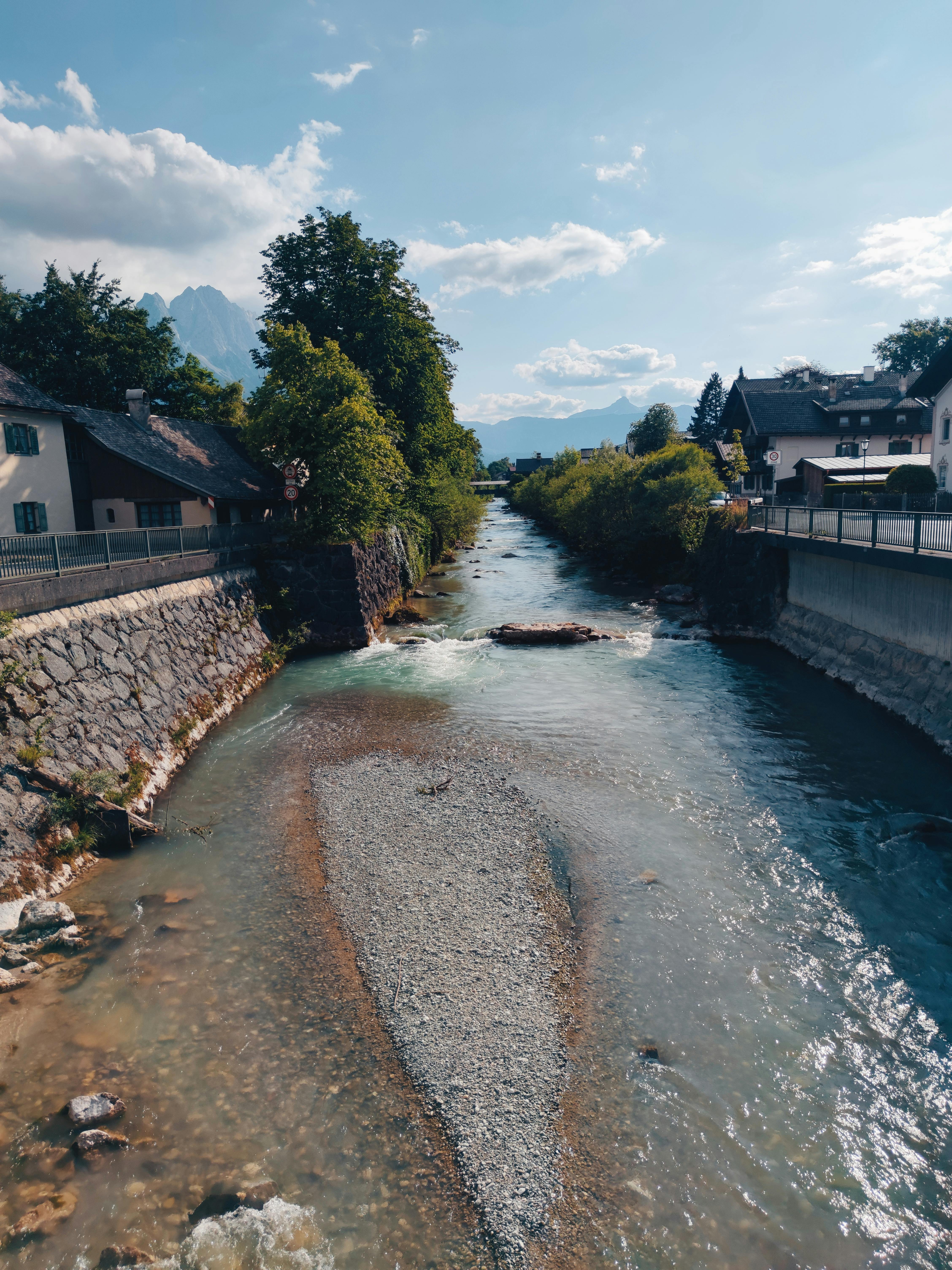 A Shallow River between Houses in a Town · Free Stock Photo