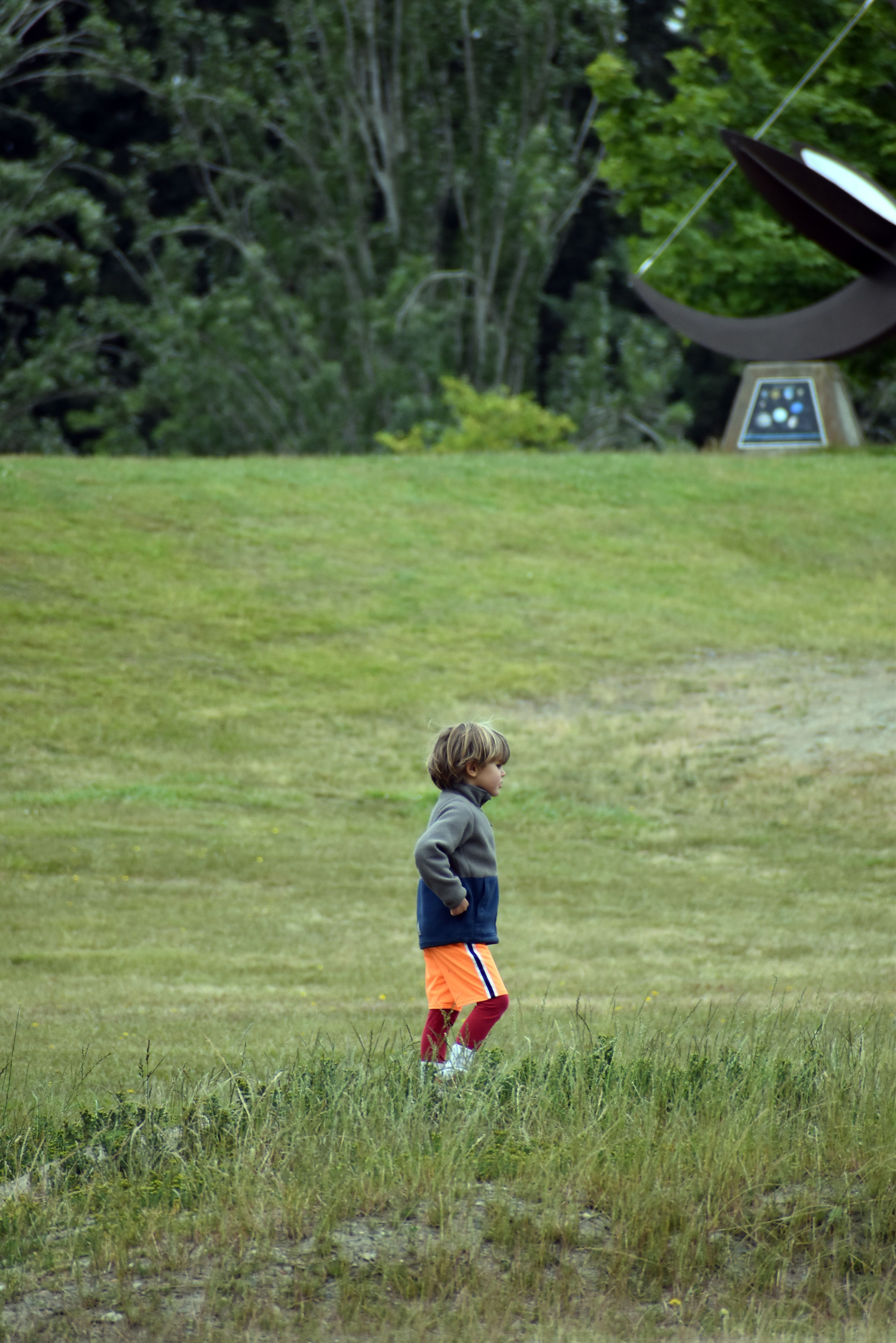Boy in Sportswear Walking on Meadow · Free Stock Photo