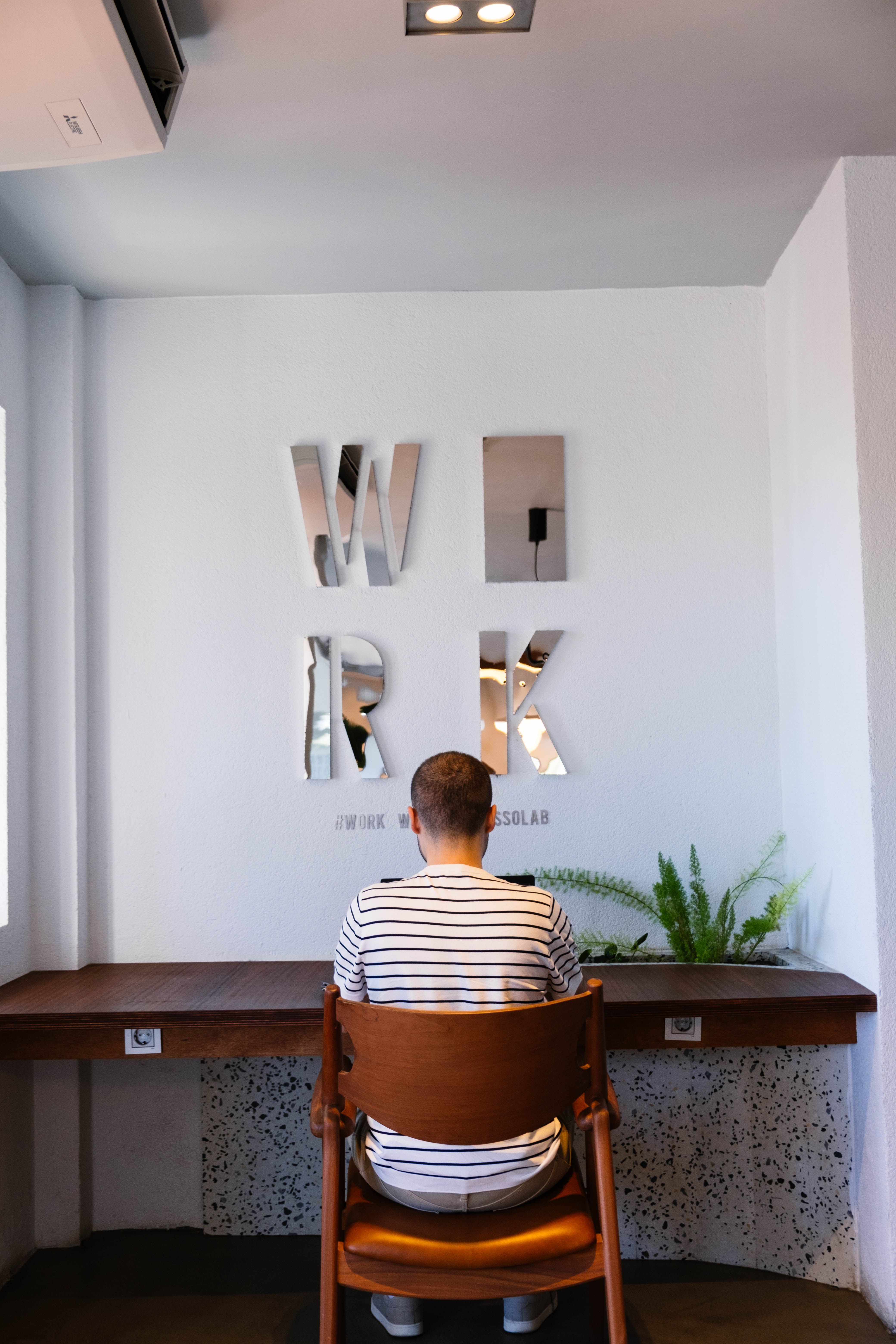 Man Sitting on Chair by Table · Free Stock Photo