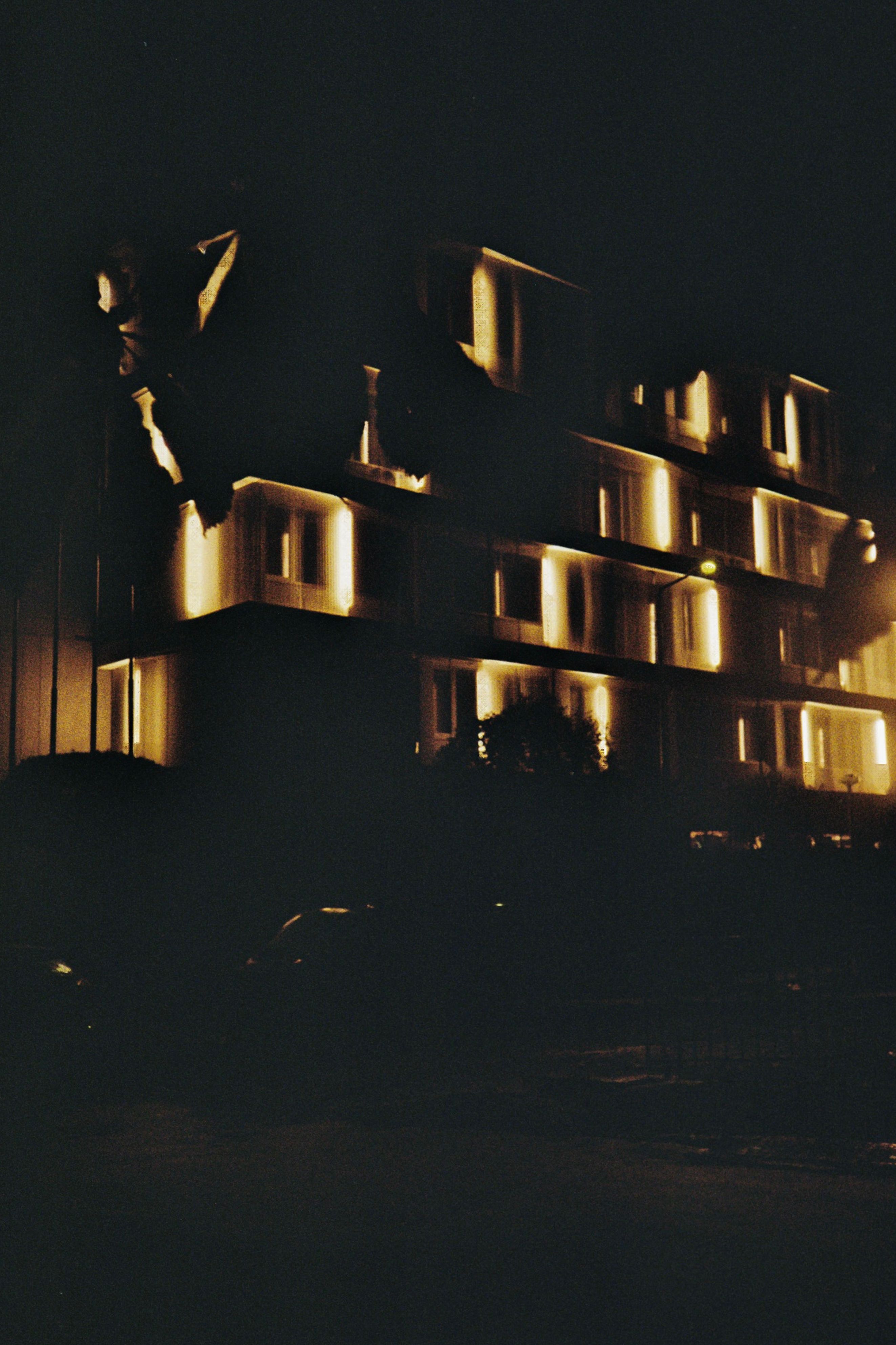 A building with lights on at night · Free Stock Photo