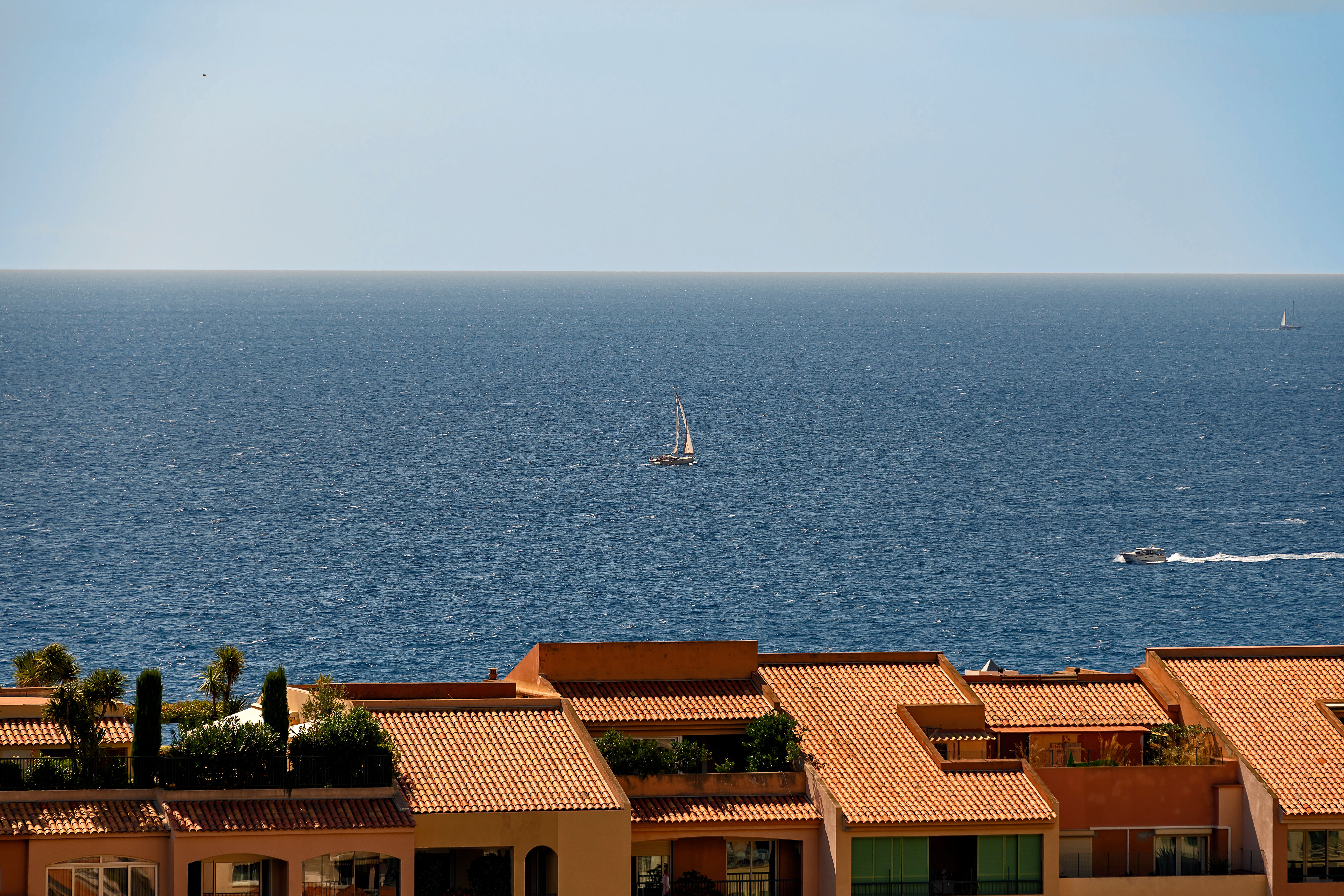 Sunlit Roofs of Buildings on Sea Shore · Free Stock Photo