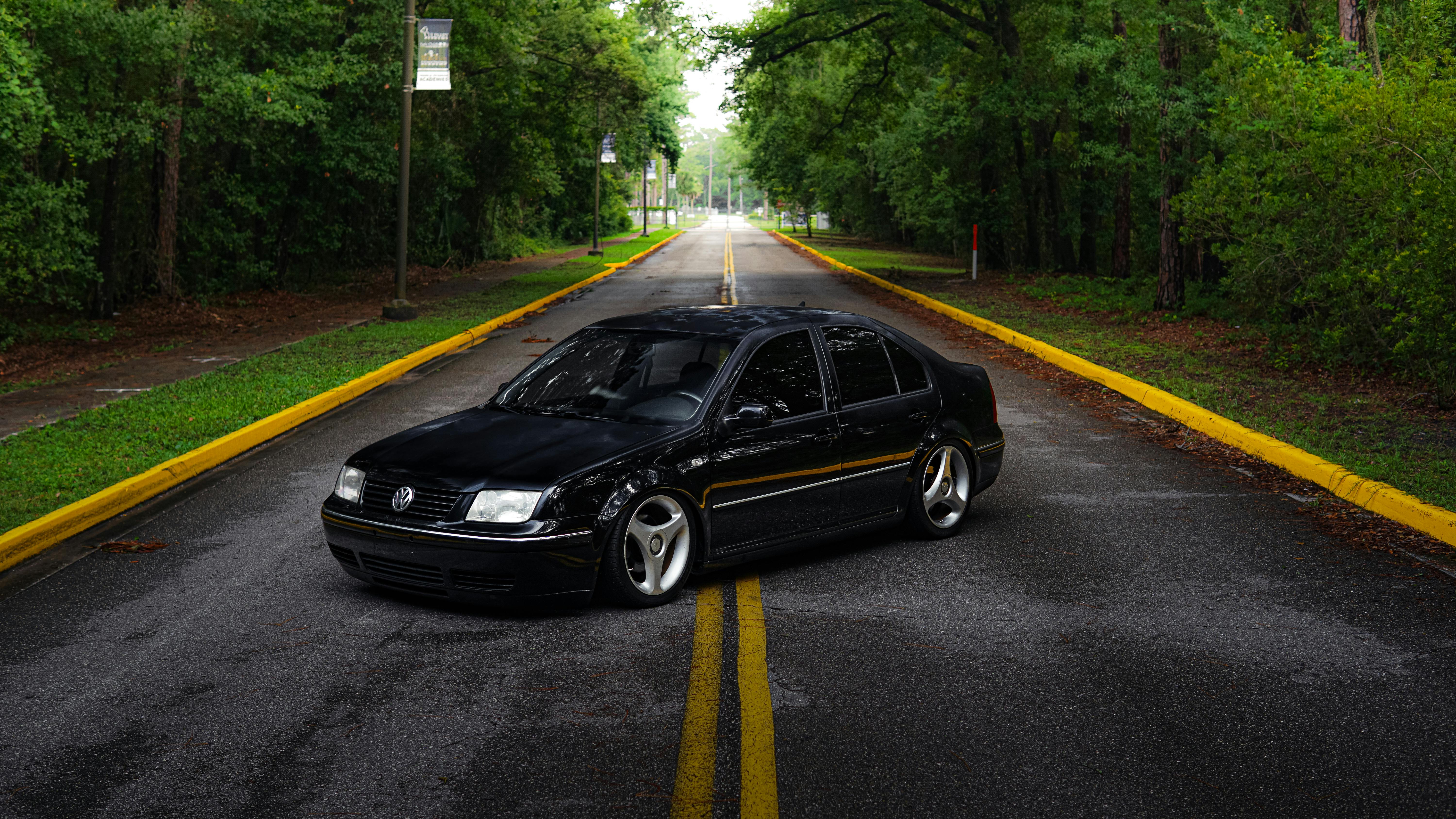 Tuned Volkswagen Jetta on Road in Forest · Free Stock Photo