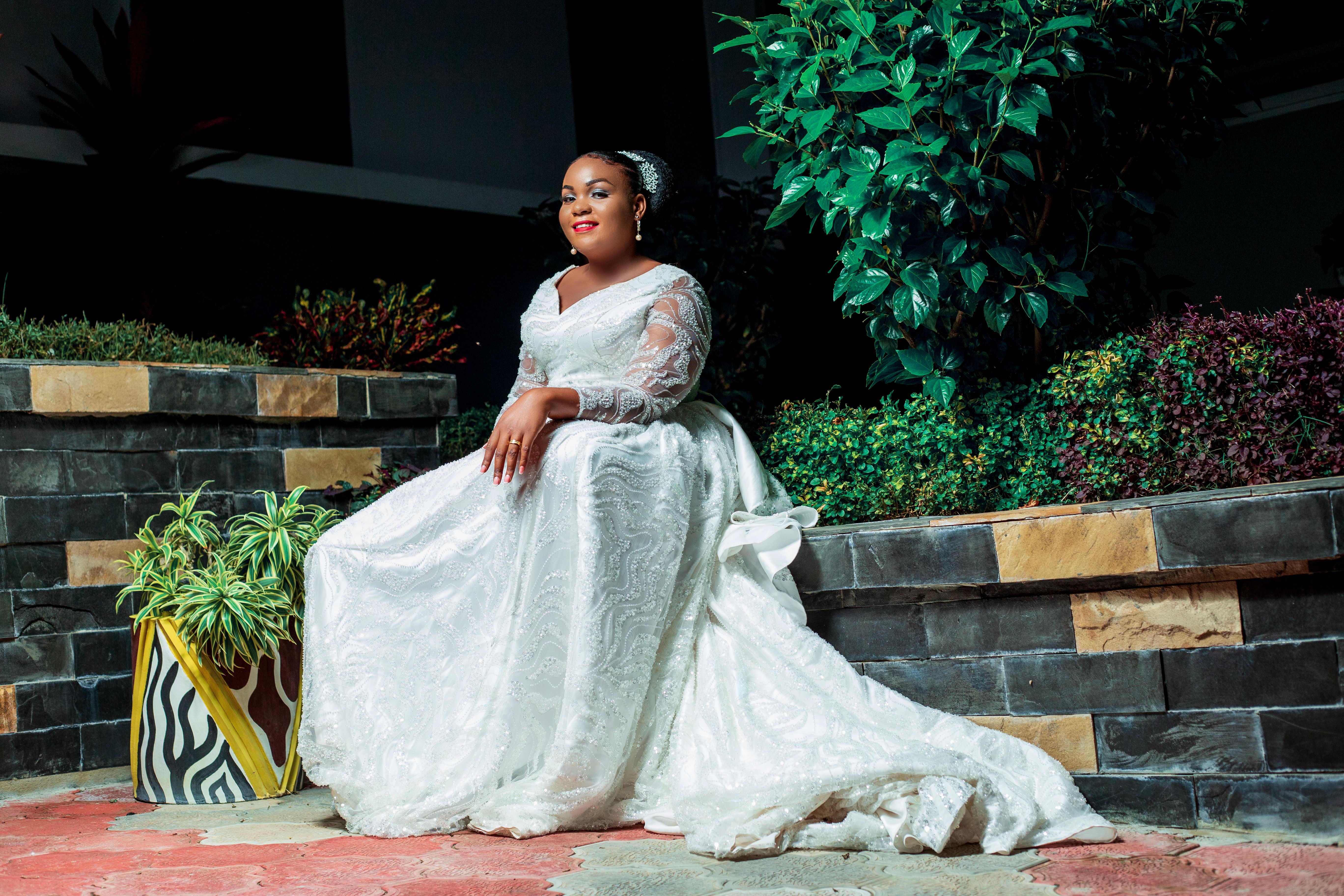 Bride Sitting on Wall and Posing · Free Stock Photo