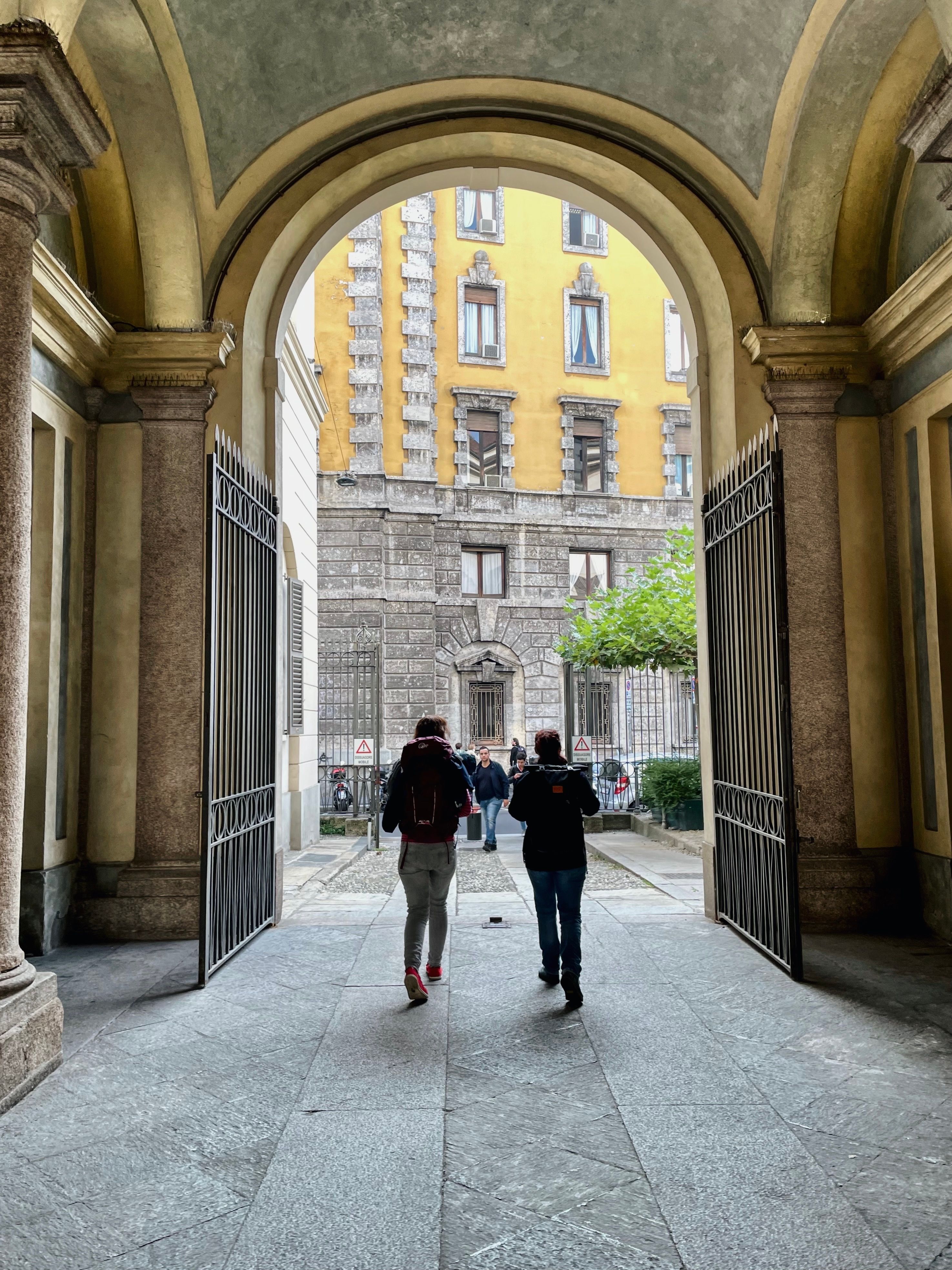 People Walking through Arched Gate · Free Stock Photo