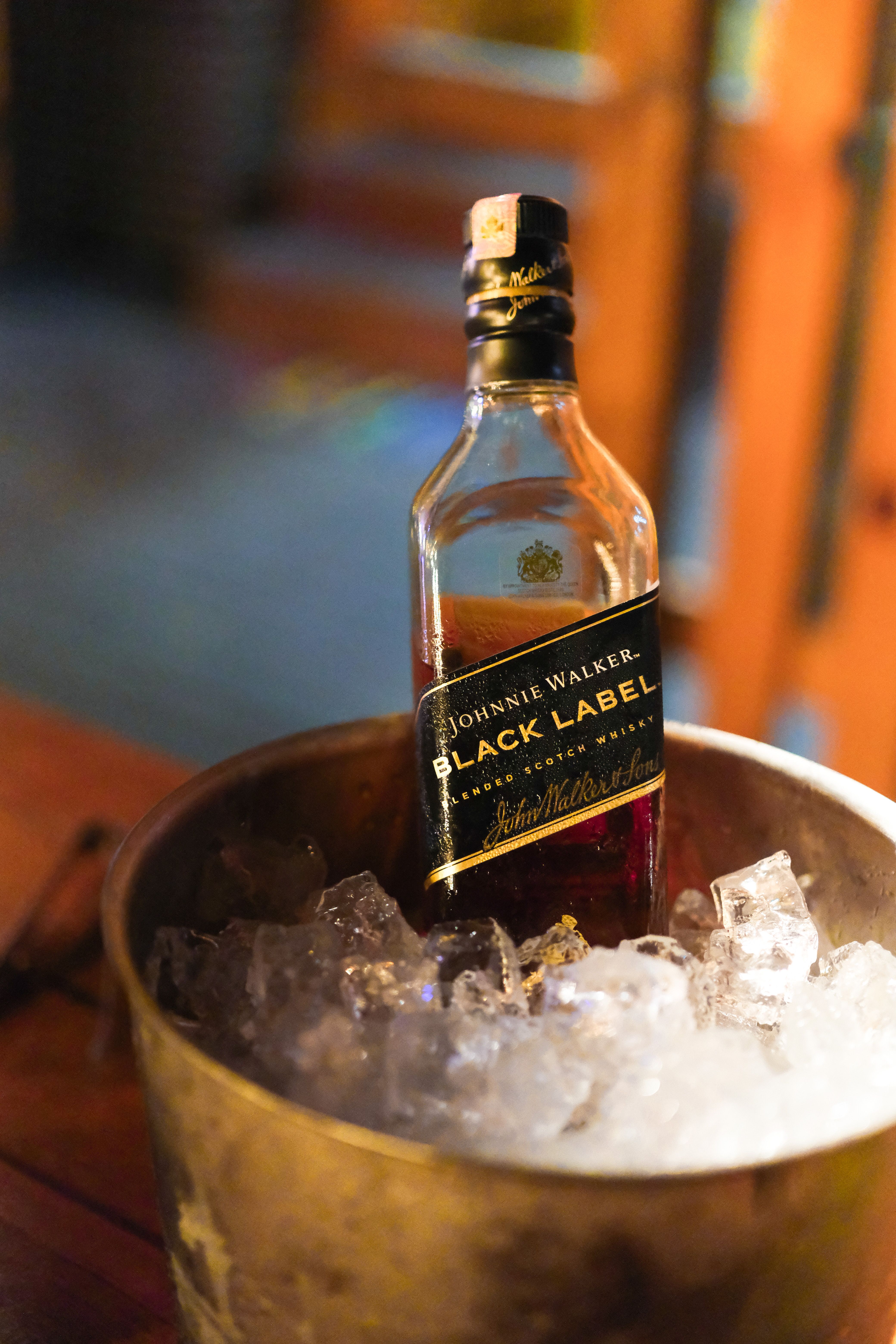 A Bottle of Whisky in a Bucket with Ice · Free Stock Photo