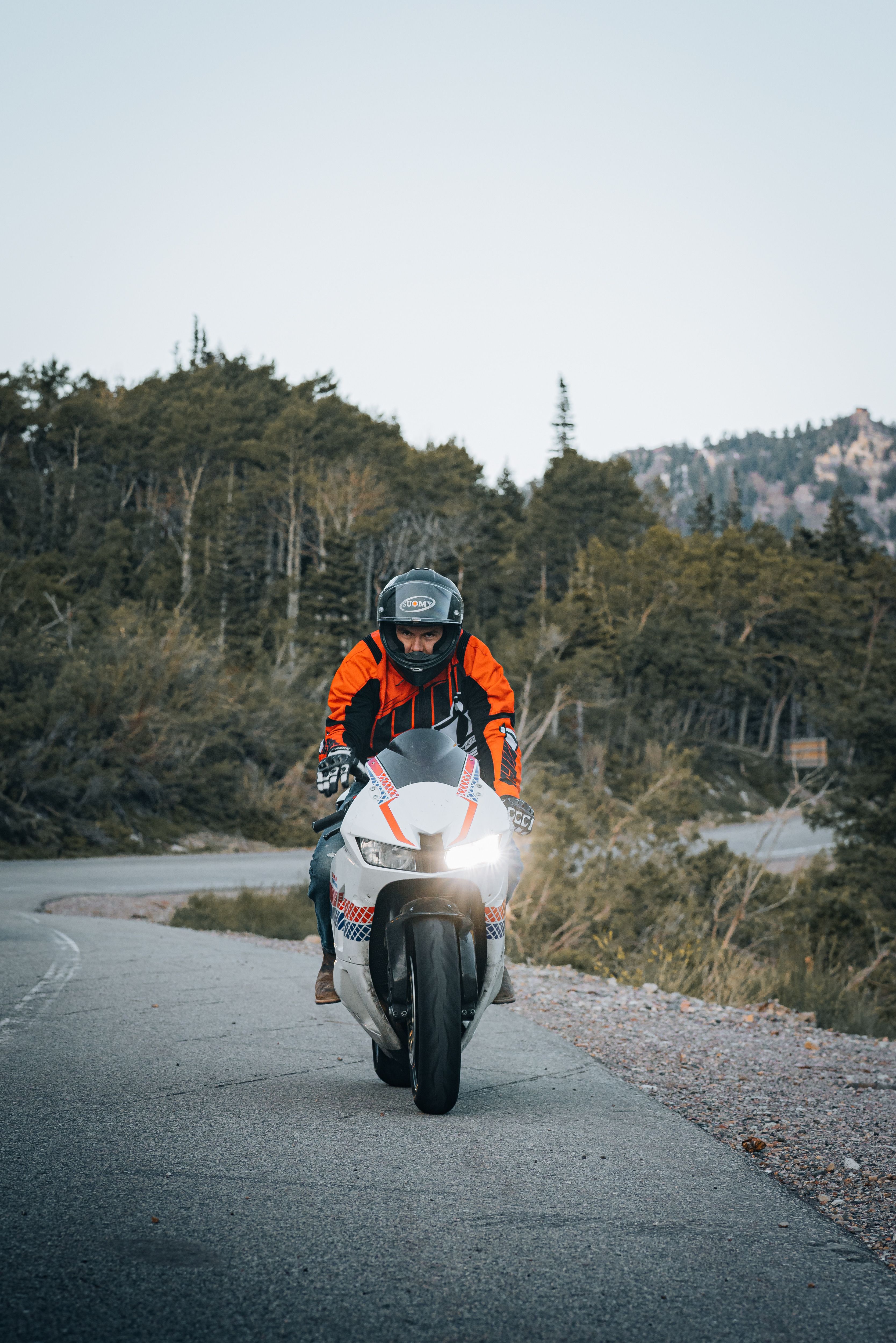 Amputee Standing between Friends Sitting on Motorcycles · Free Stock Photo