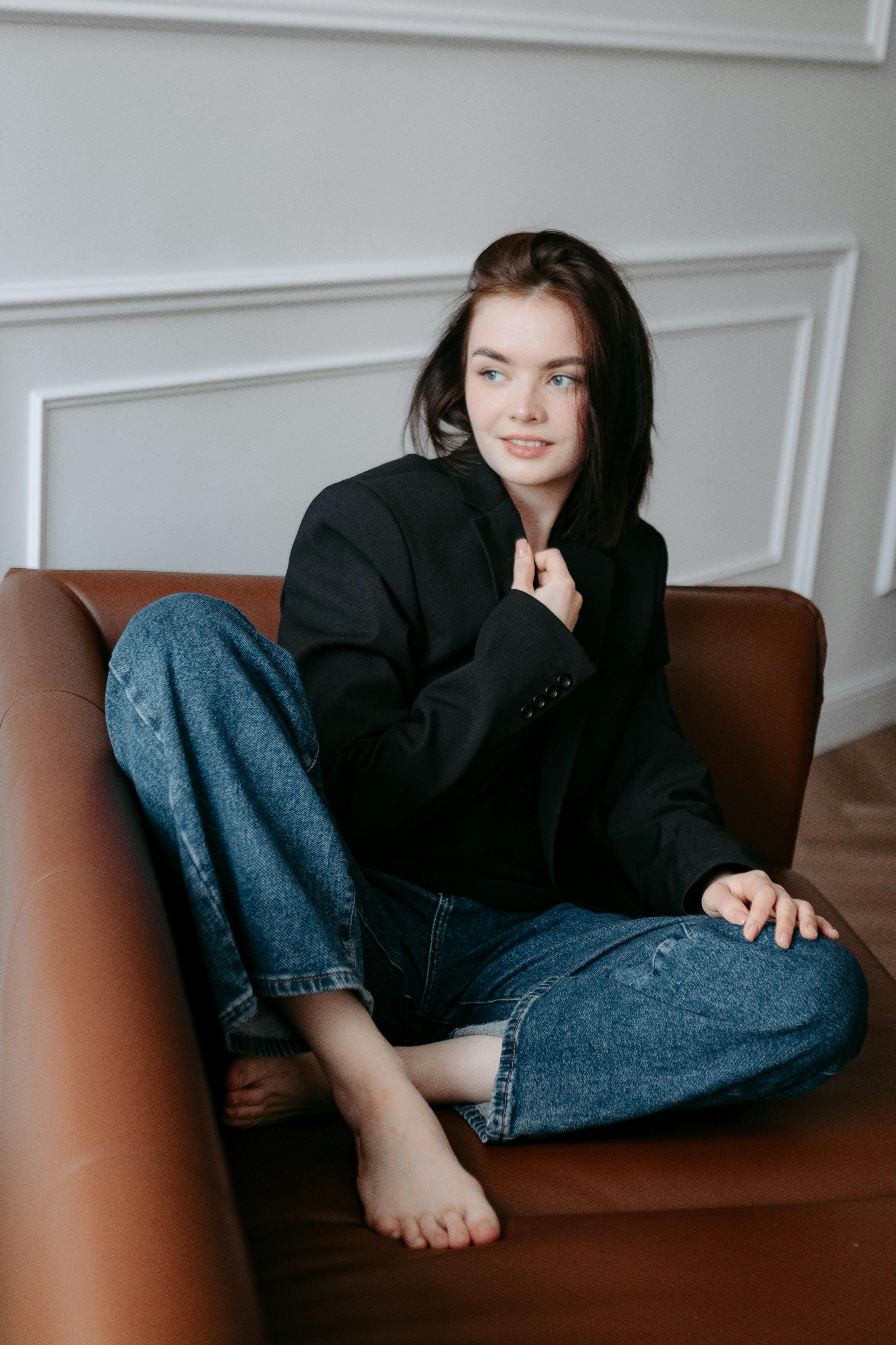 Woman Sitting on Leather Sofa · Free Stock Photo