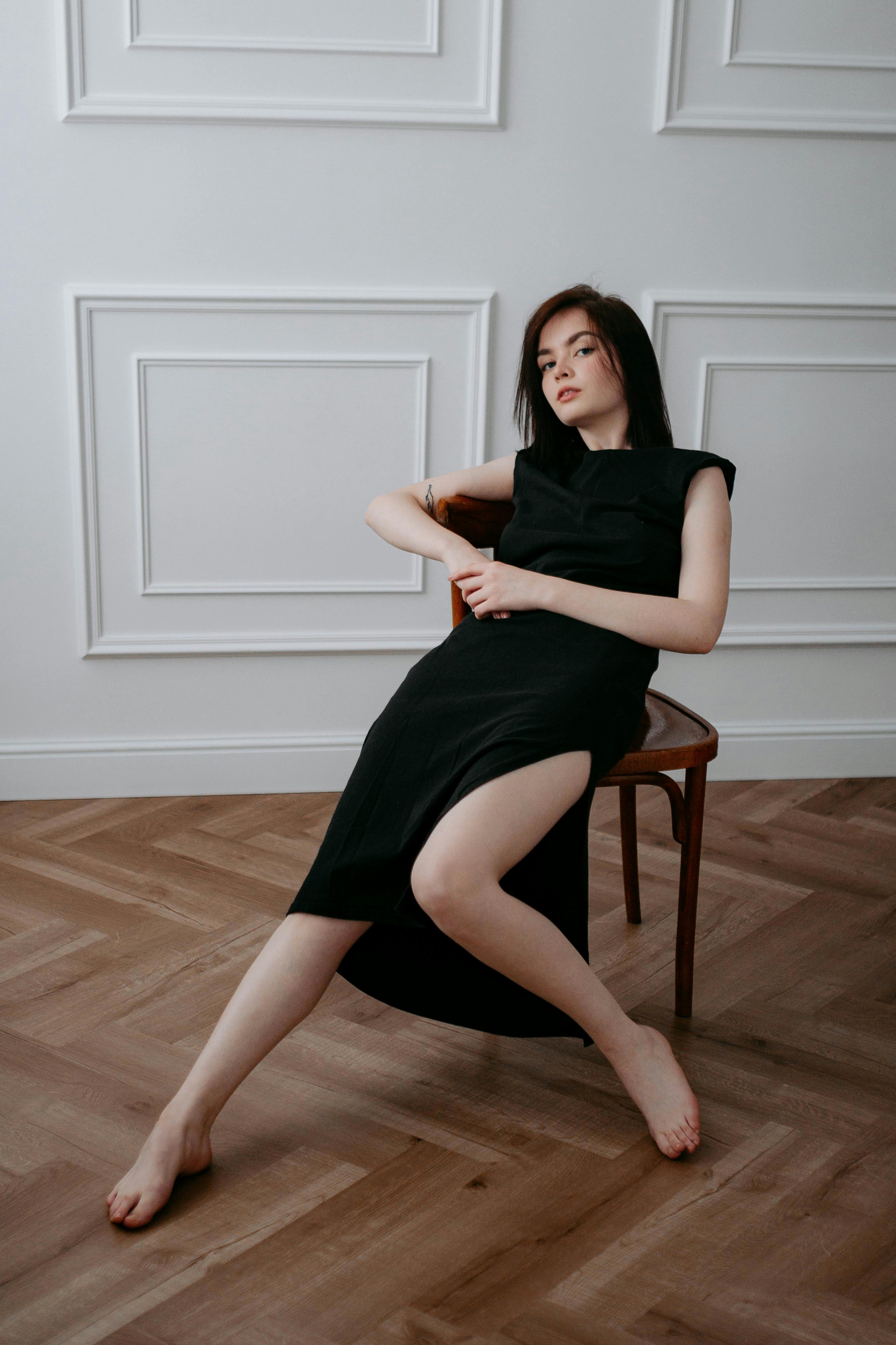 Elegant Woman in a Black Dress Sitting on a Chair · Free Stock Photo