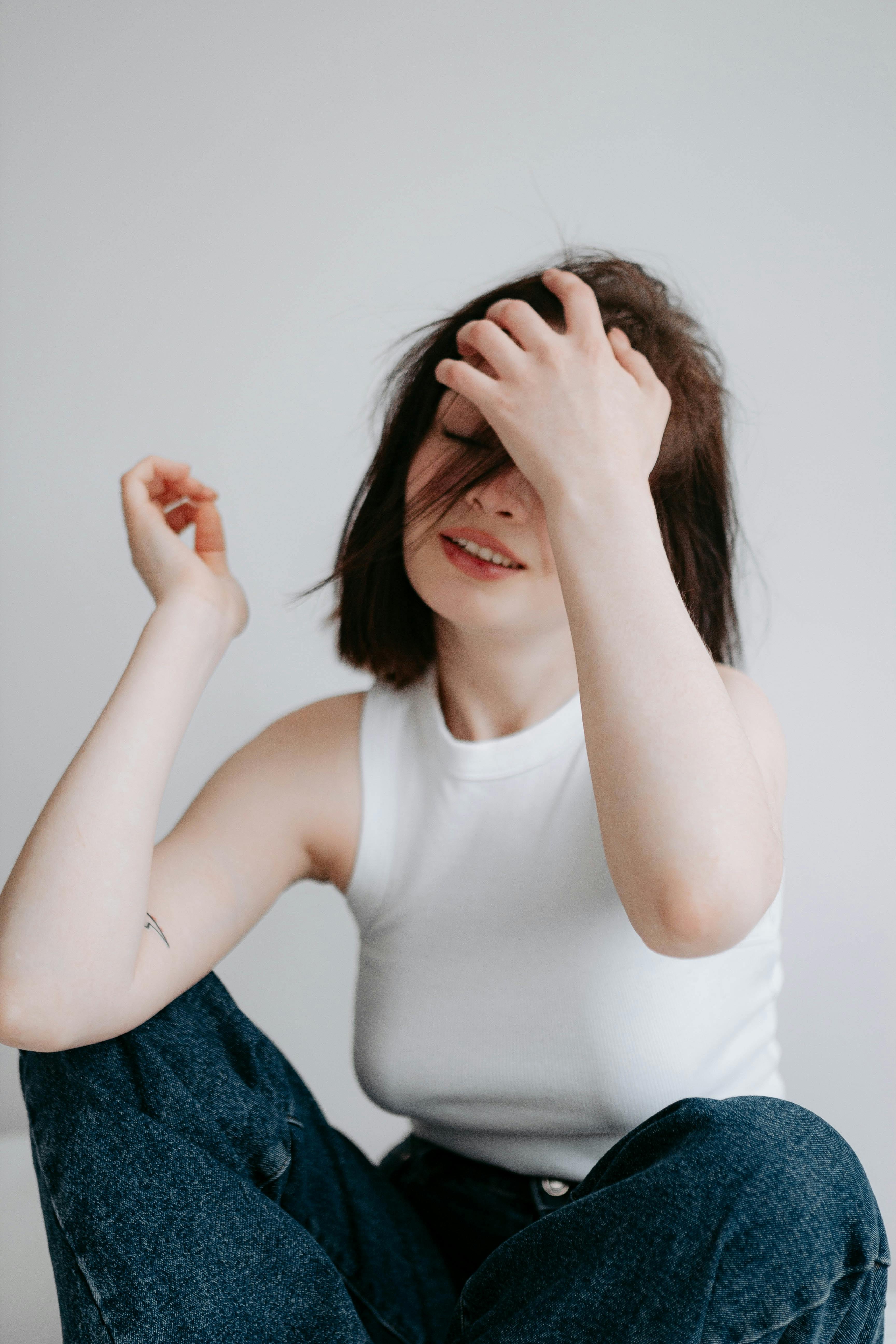 Young Woman in a Simple Outfit Posing in Studio · Free Stock Photo