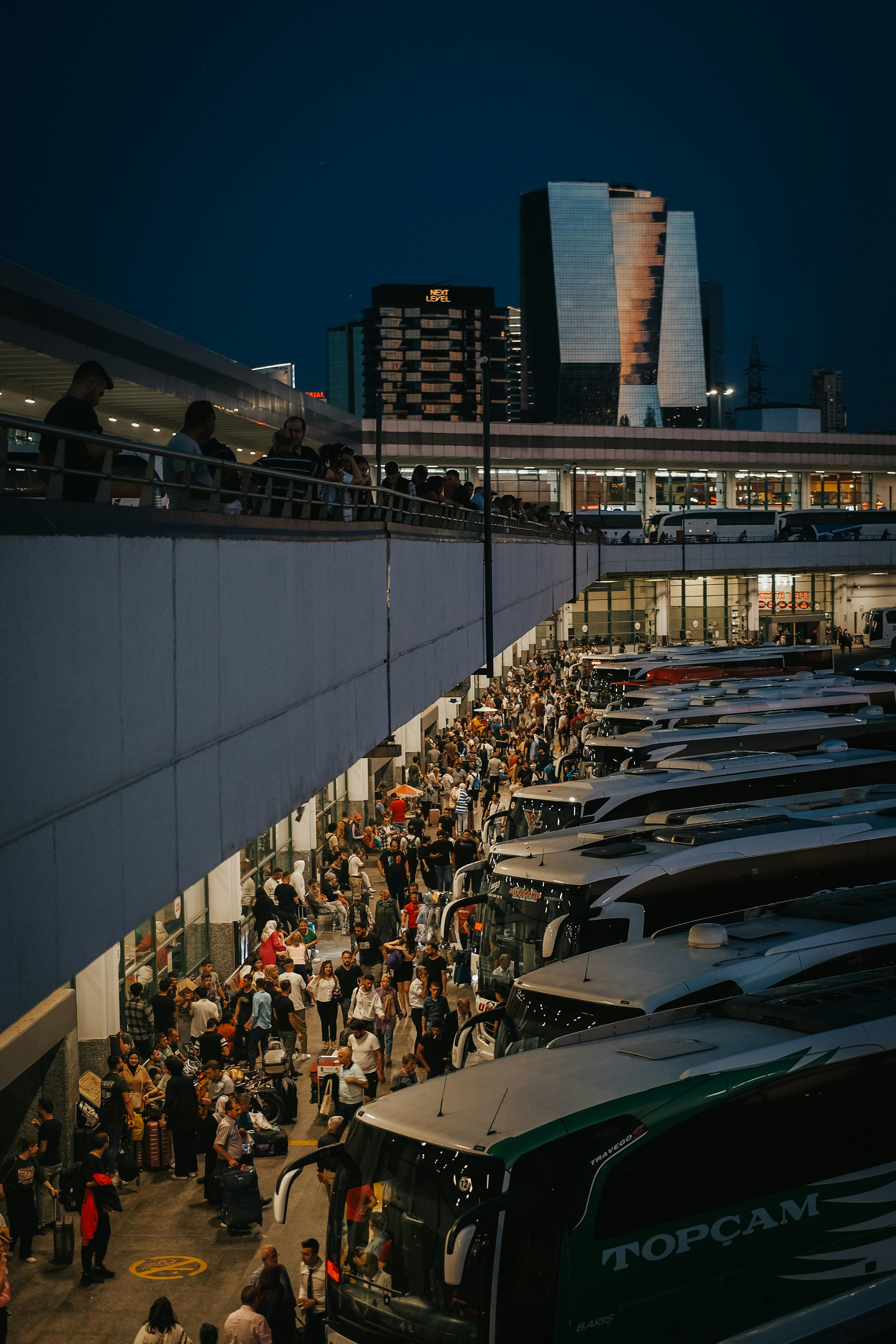 View of a Crowded Bus Station and Coaches Parked along the Building ...