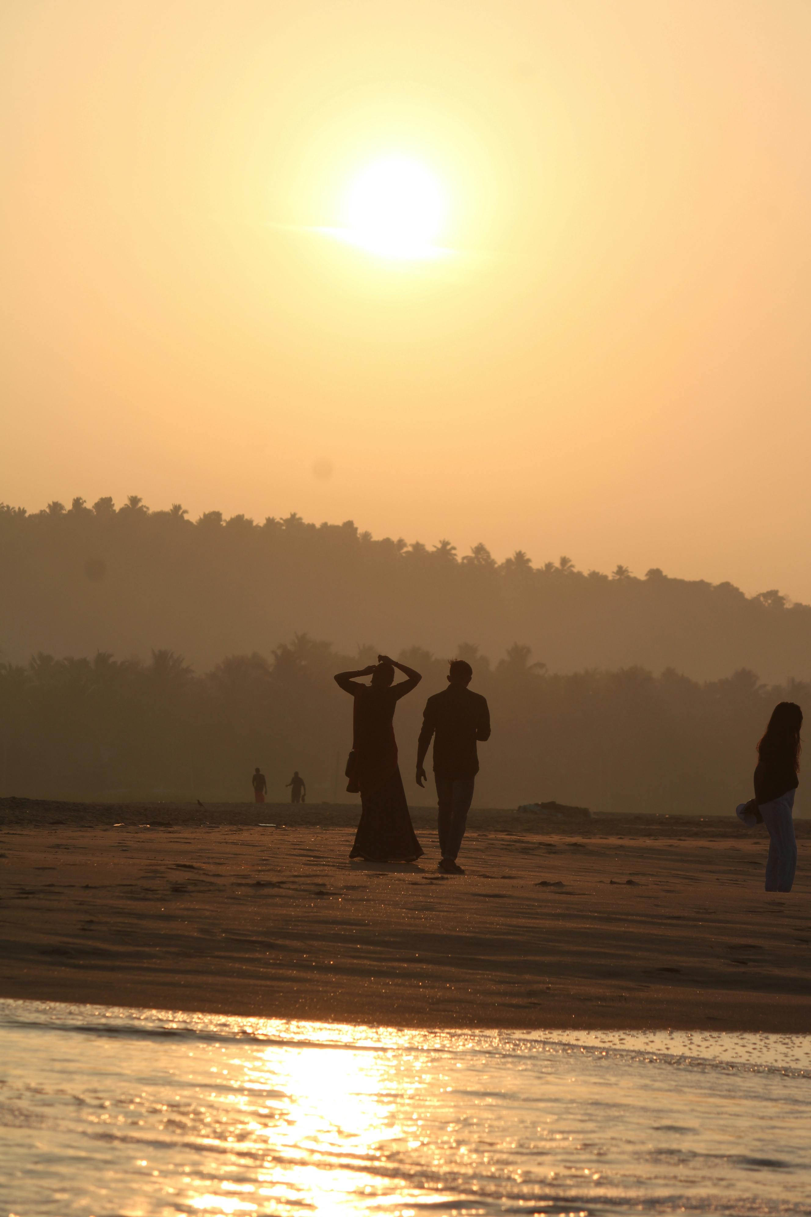 People on the Beach at Sunset · Free Stock Photo