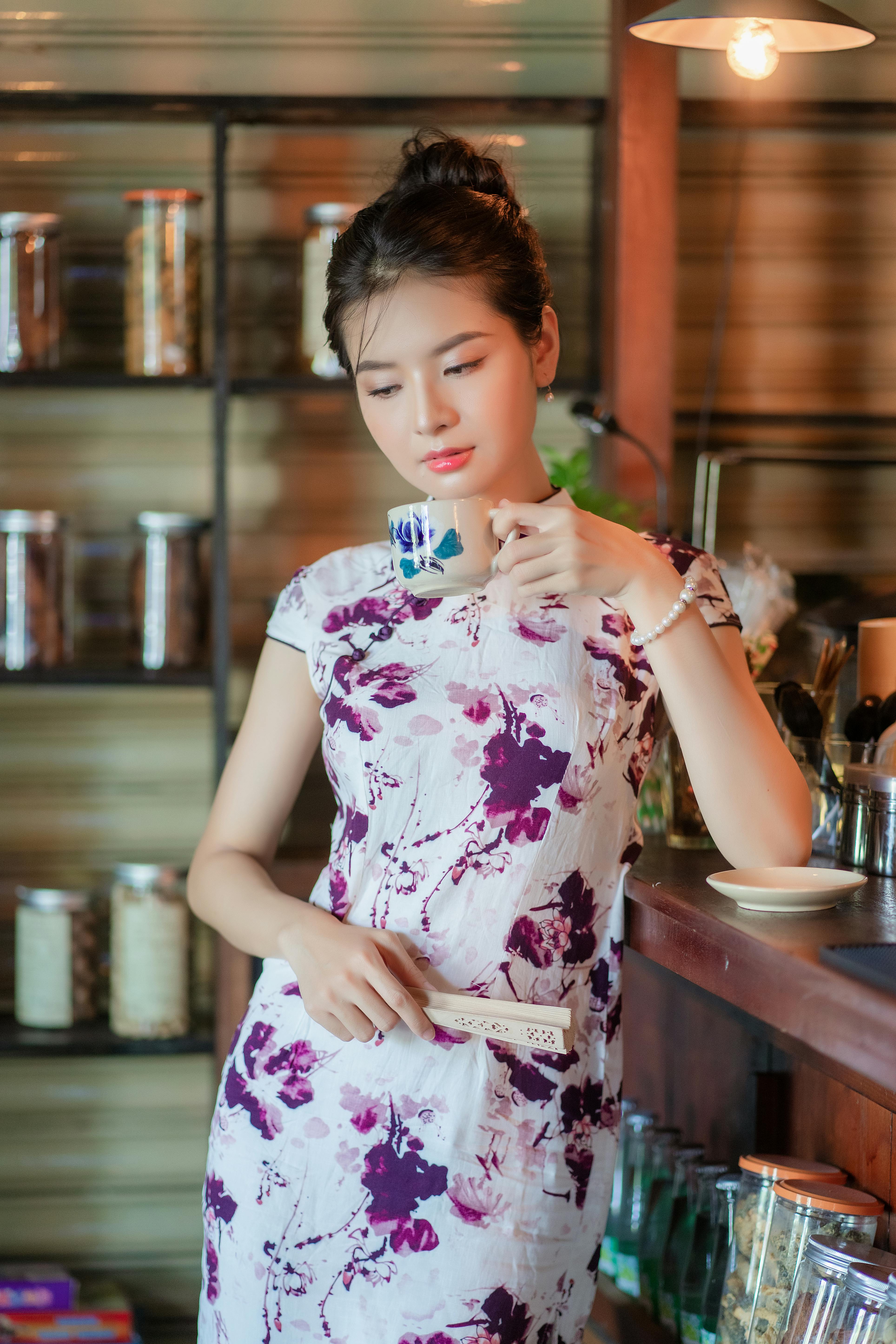 Model in Floral Dress Drinking Tea · Free Stock Photo