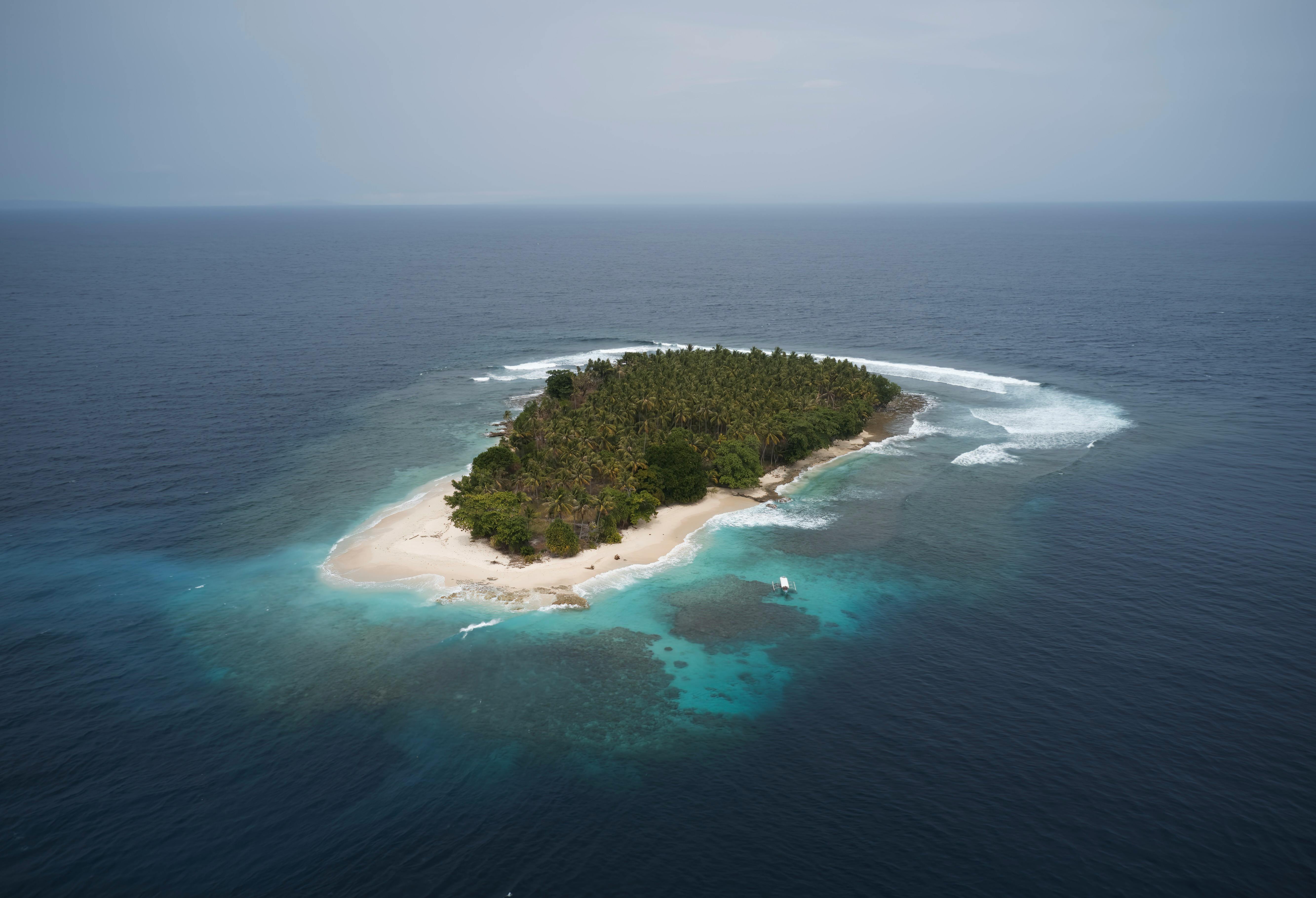 Aerial of an Uninhabited Tropical Island on a Sea · Free Stock Photo