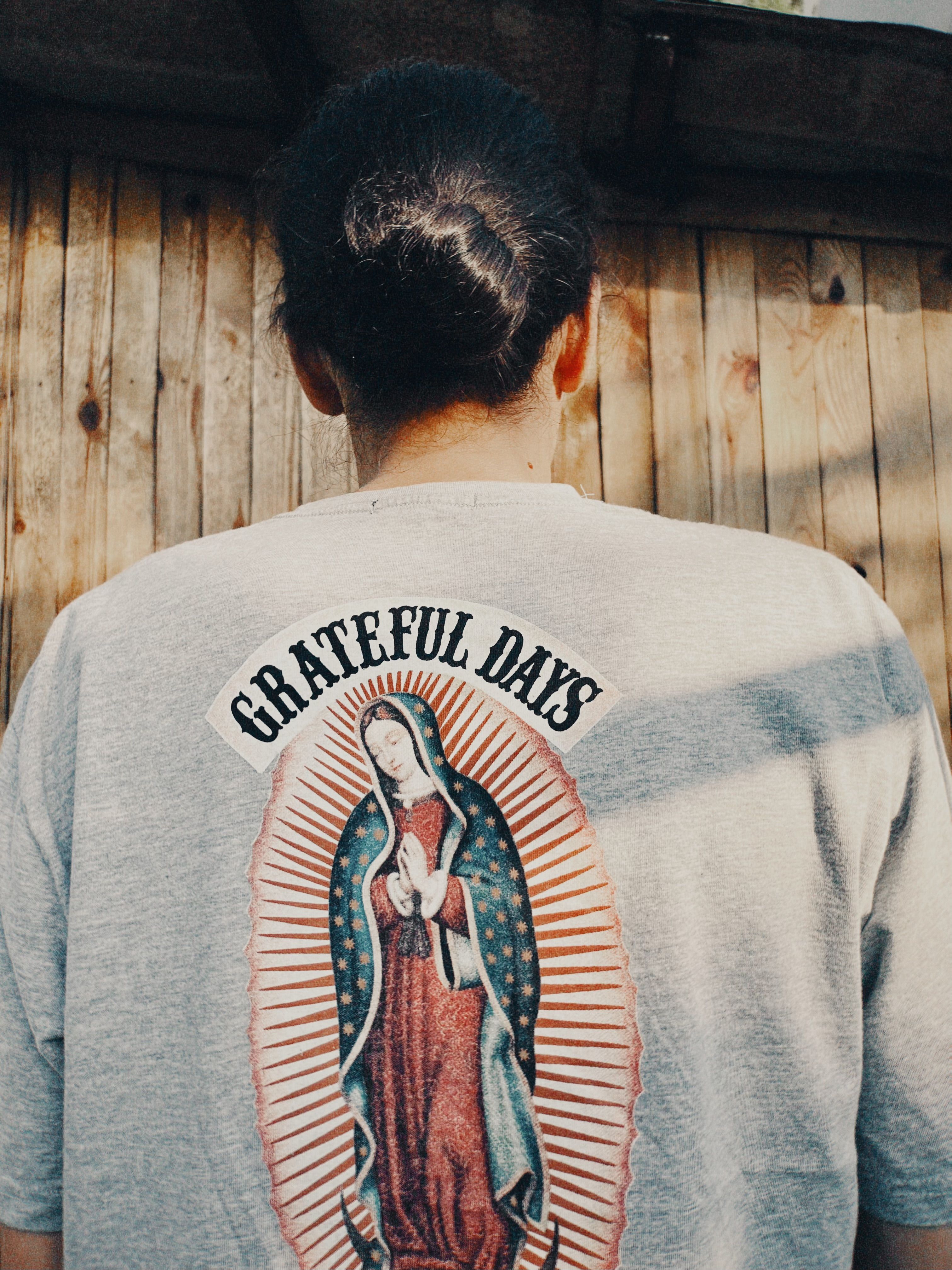 Back View of Person with Virgin Mary on Clothes · Free Stock Photo