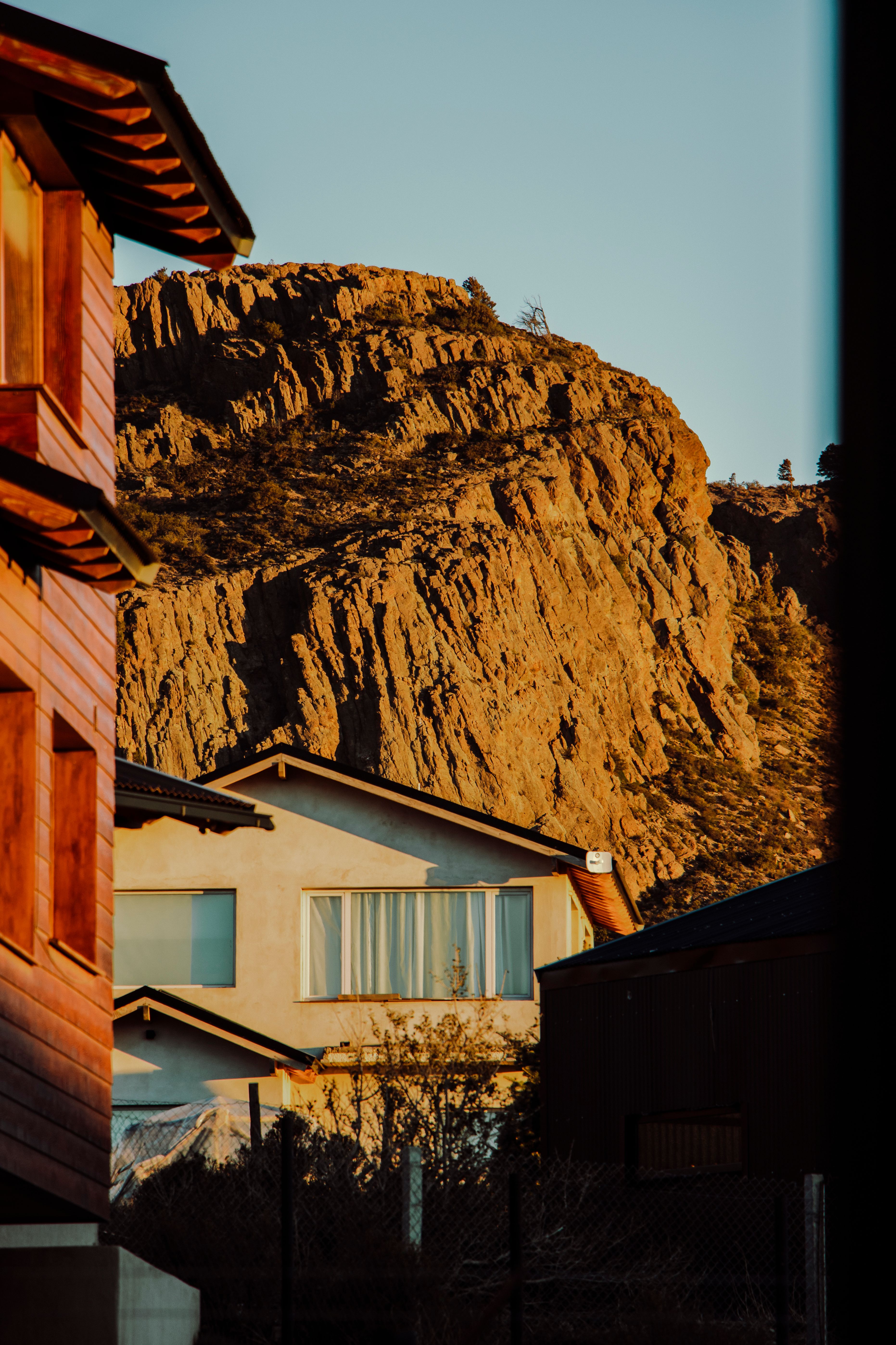 Rock Formation over Building in Town · Free Stock Photo