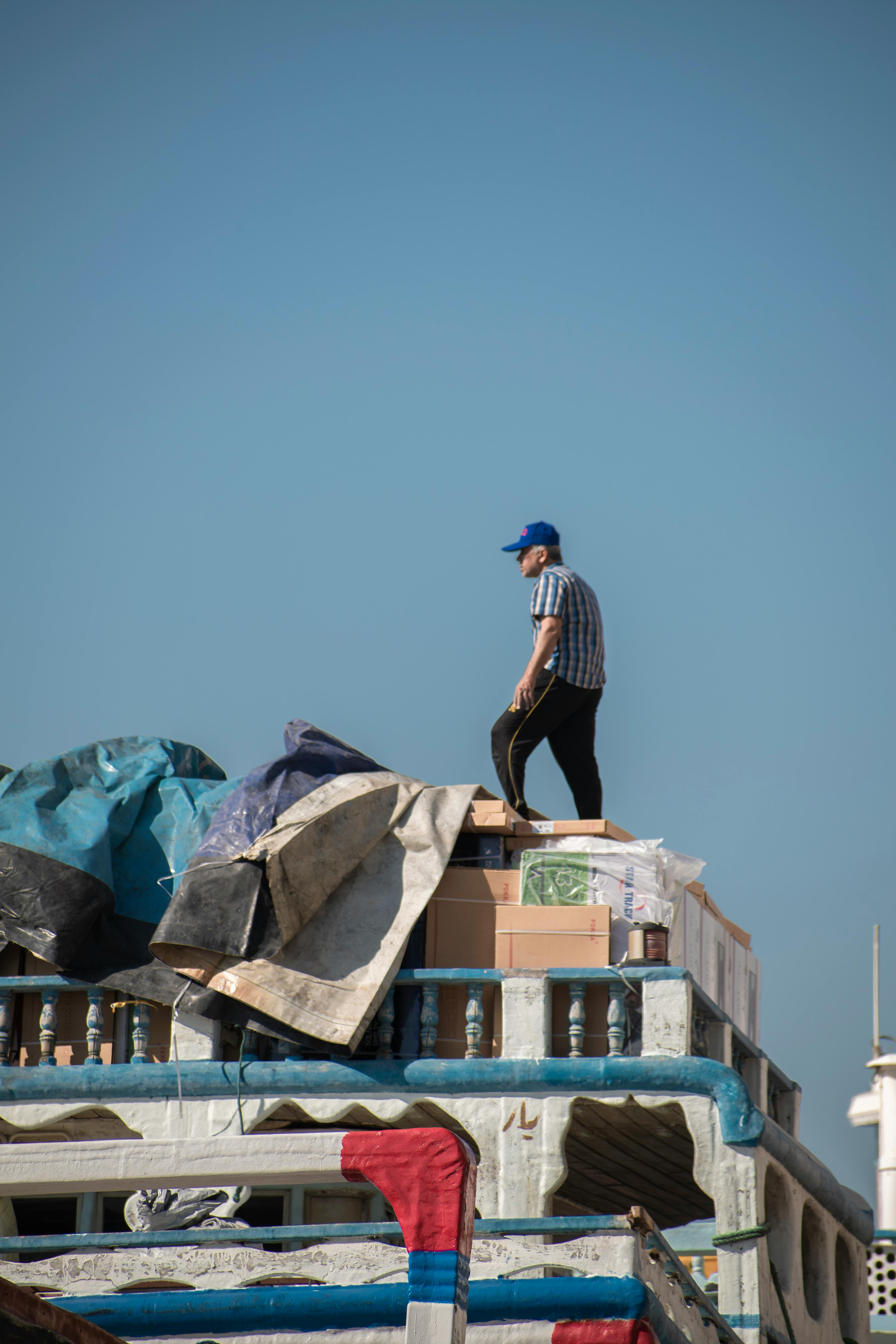 Man on Building Roof · Free Stock Photo